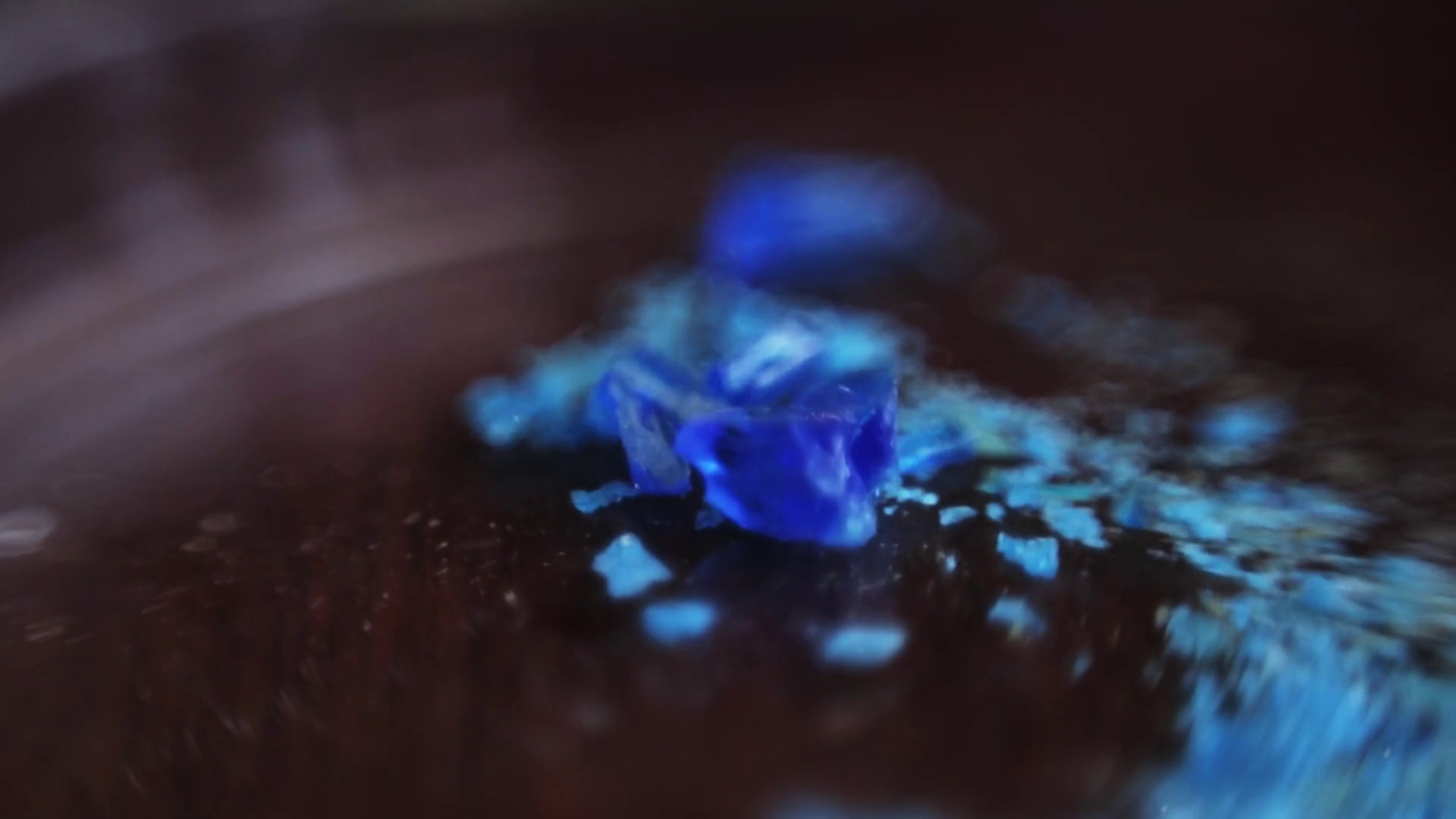 Blue samples of precious metals. Particles of minerals lying on table ...