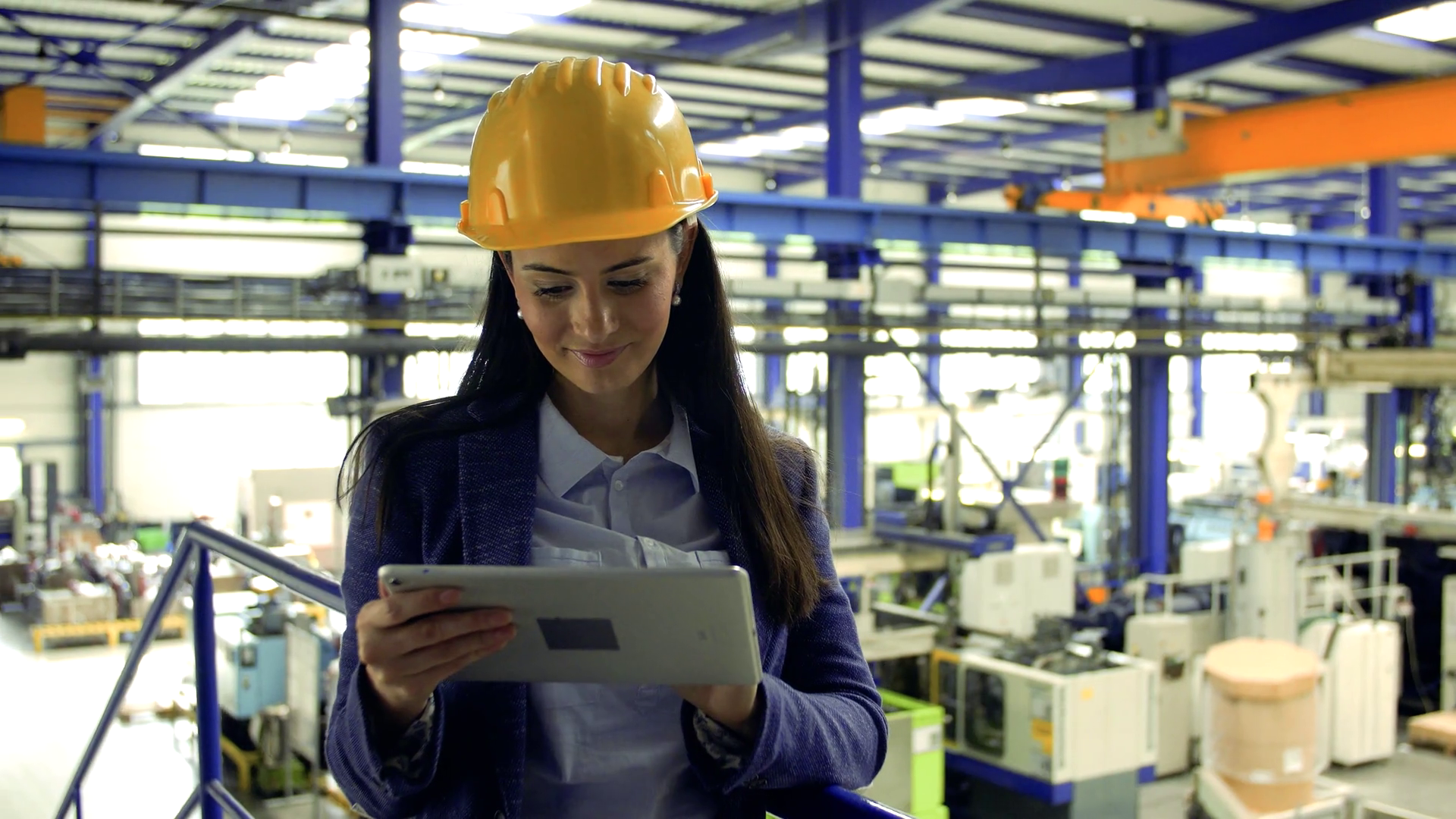 A portrait of an industrial woman engineer in a factory standing with a ...