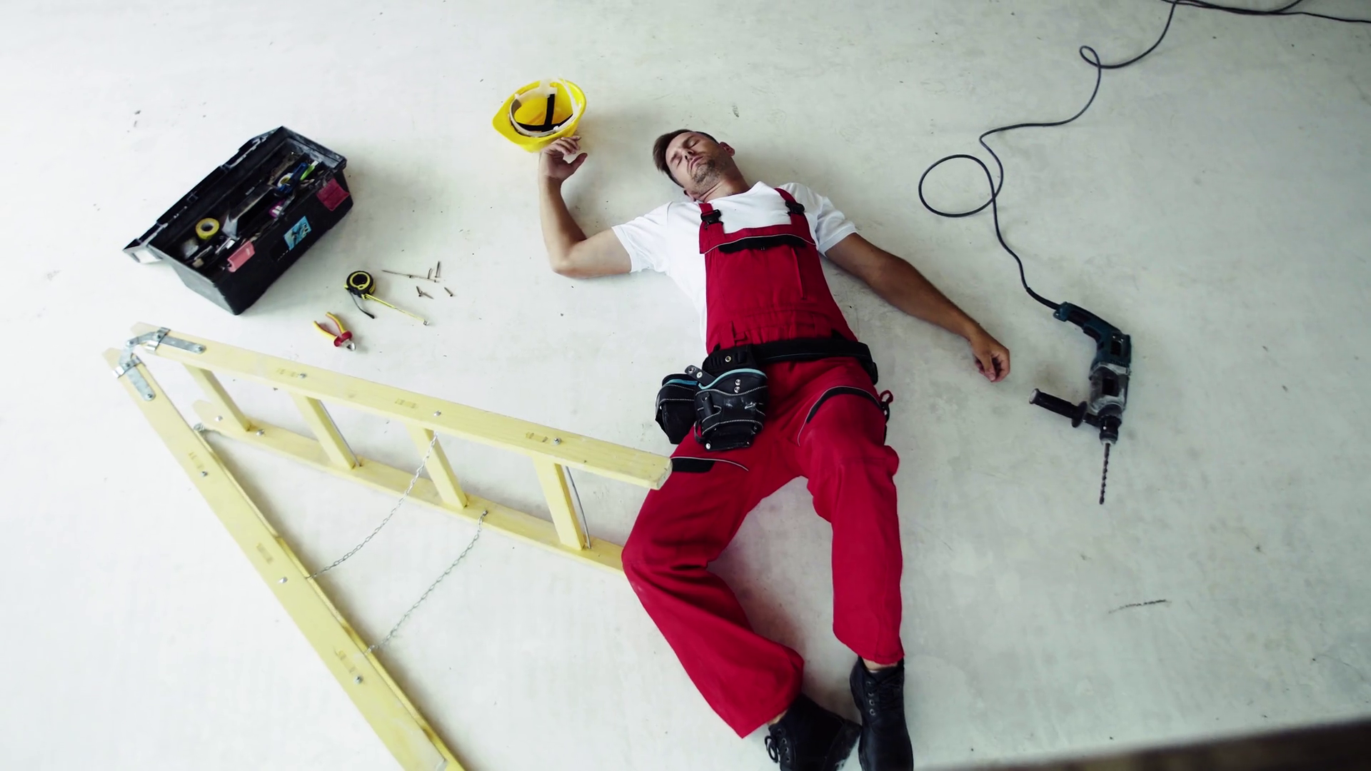 Top view of an injured man in pain lying on the floor after an accident ...