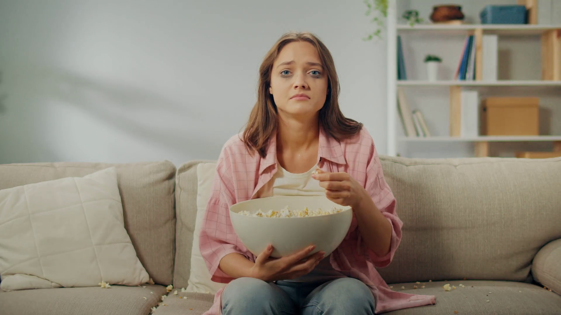 A Young Woman Sitting On Sofa Eating Popcorn Stock Footage SBV ...