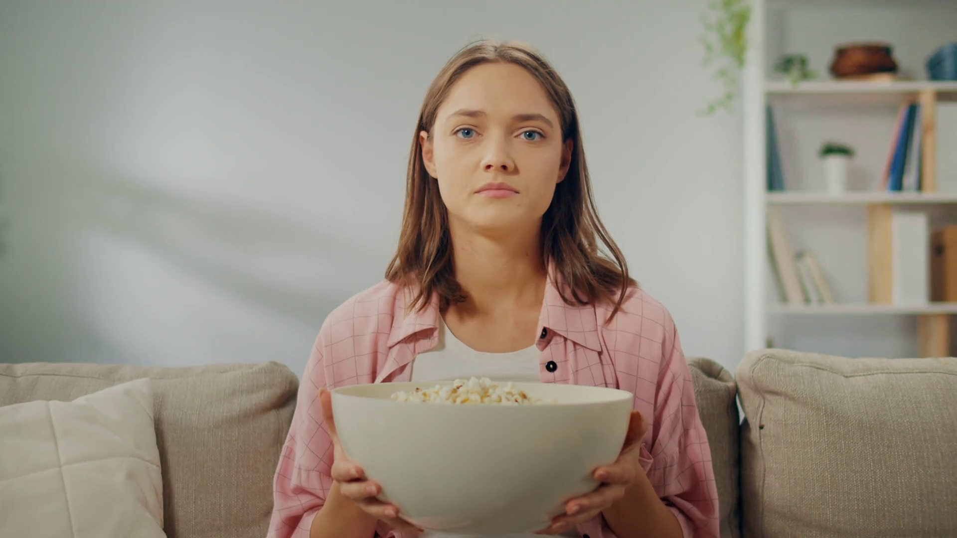 A Young Woman Sitting On Sofa Eating Popcorn Stock Footage SBV ...