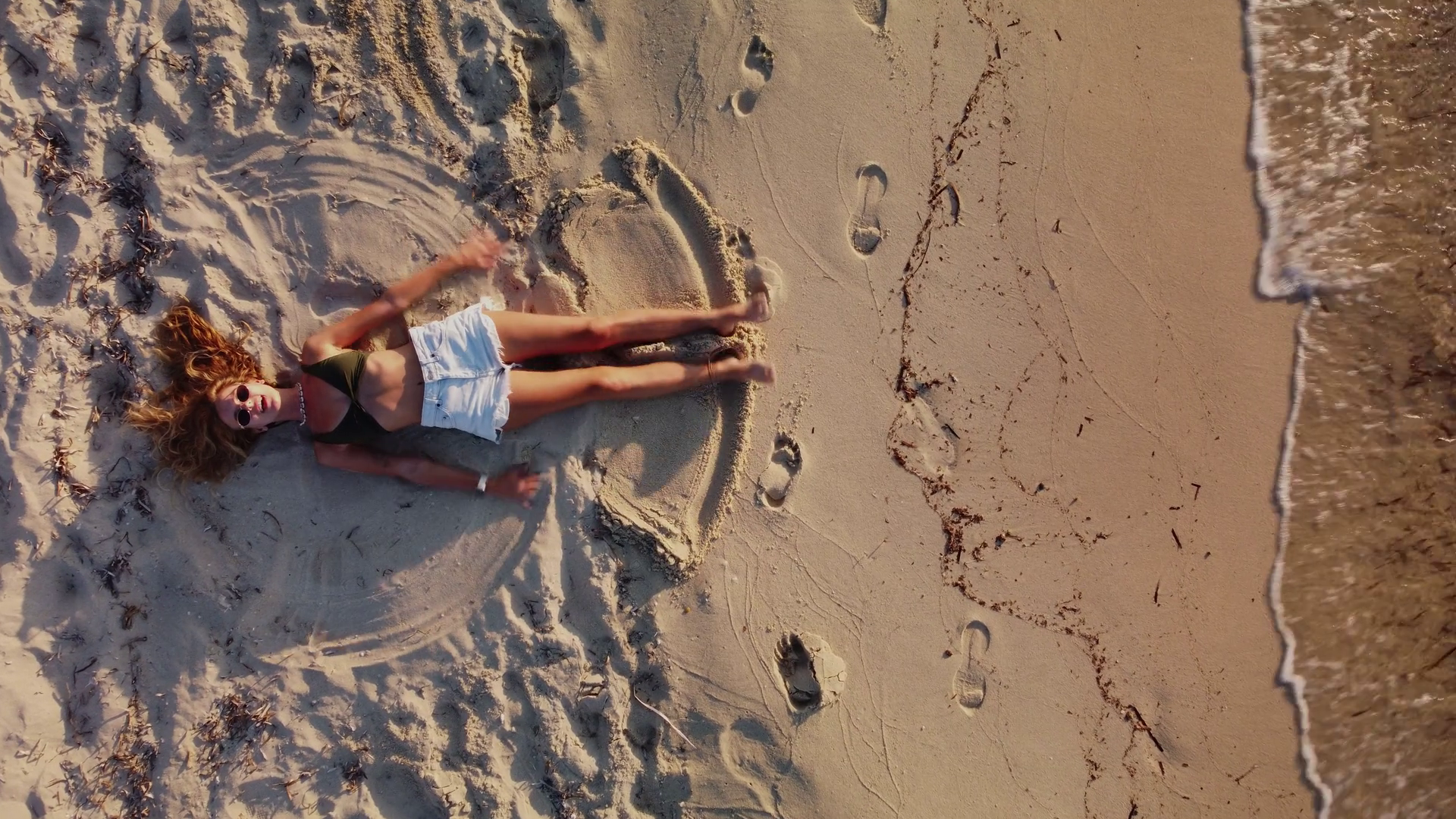 Woman Making Sand Angel On Sunny Beach: Stock Footage SBV-352345763 ...