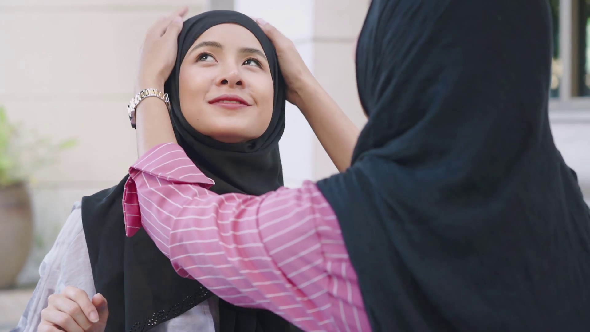 Two Young Muslim females friends helping each other wearing hijab, life ...