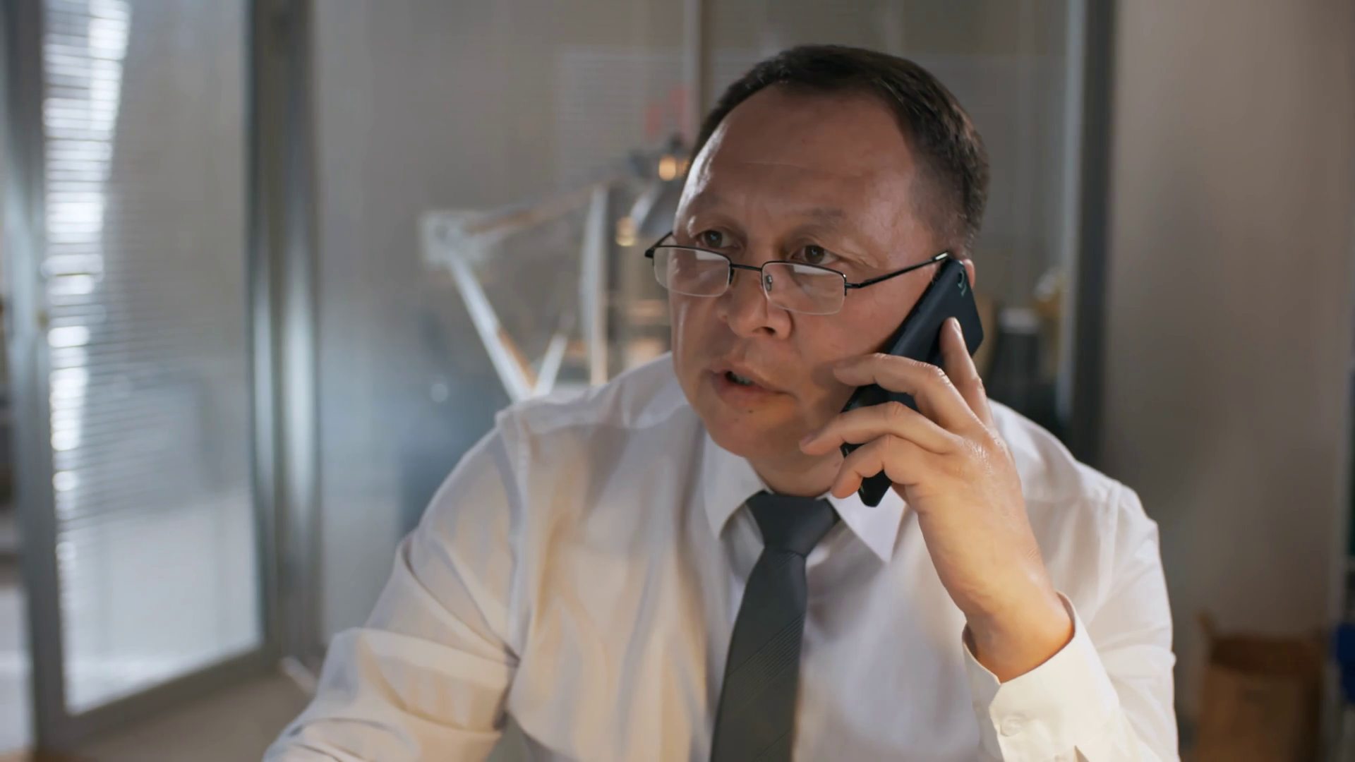 close-up-of-concentrated-middle-aged-businessman-in-eyeglasses-looking