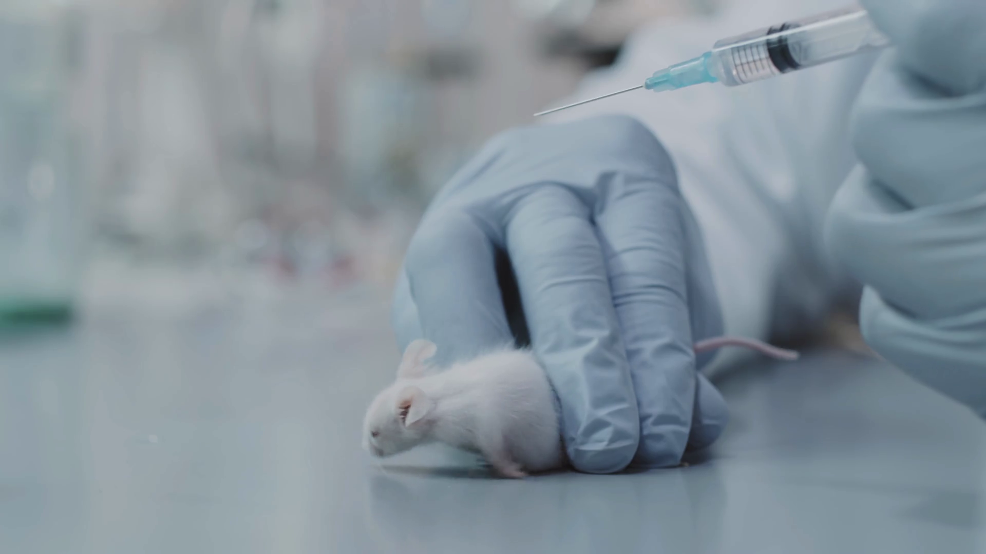 Close up slowmo of unrecognizable scientist in gloves holding syringe ...