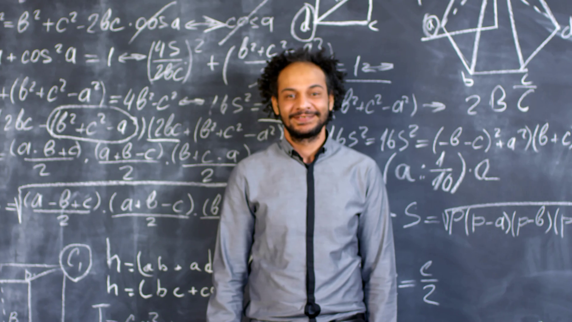 Dolly-in shot of cheerful male university professor standing before ...