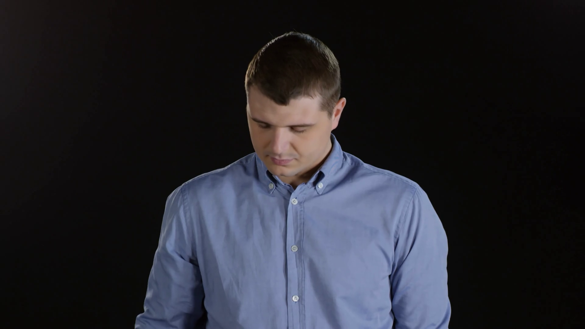 Medium shot of amputee man in shirt standing isolated on black ...