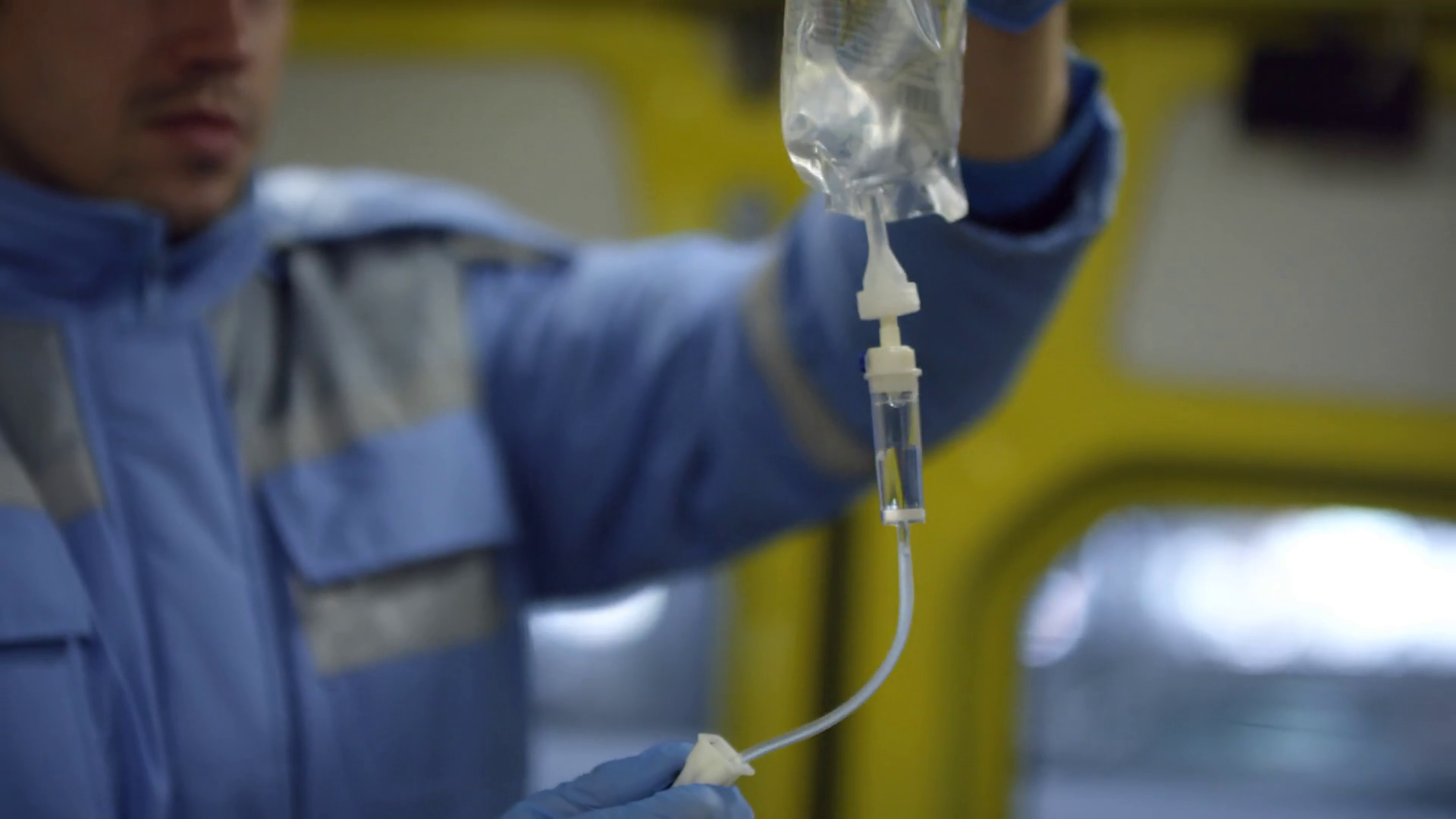 Sequence of shots of male and female paramedics starting intravenous ...