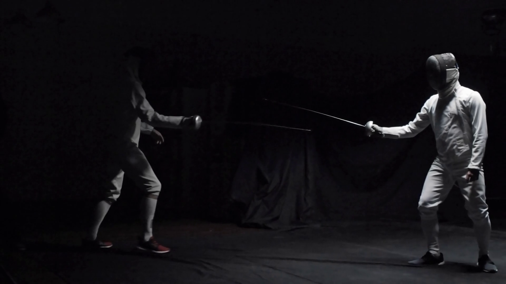 Slow motion of fencer hitting shoulder of his opponent during fight in ...