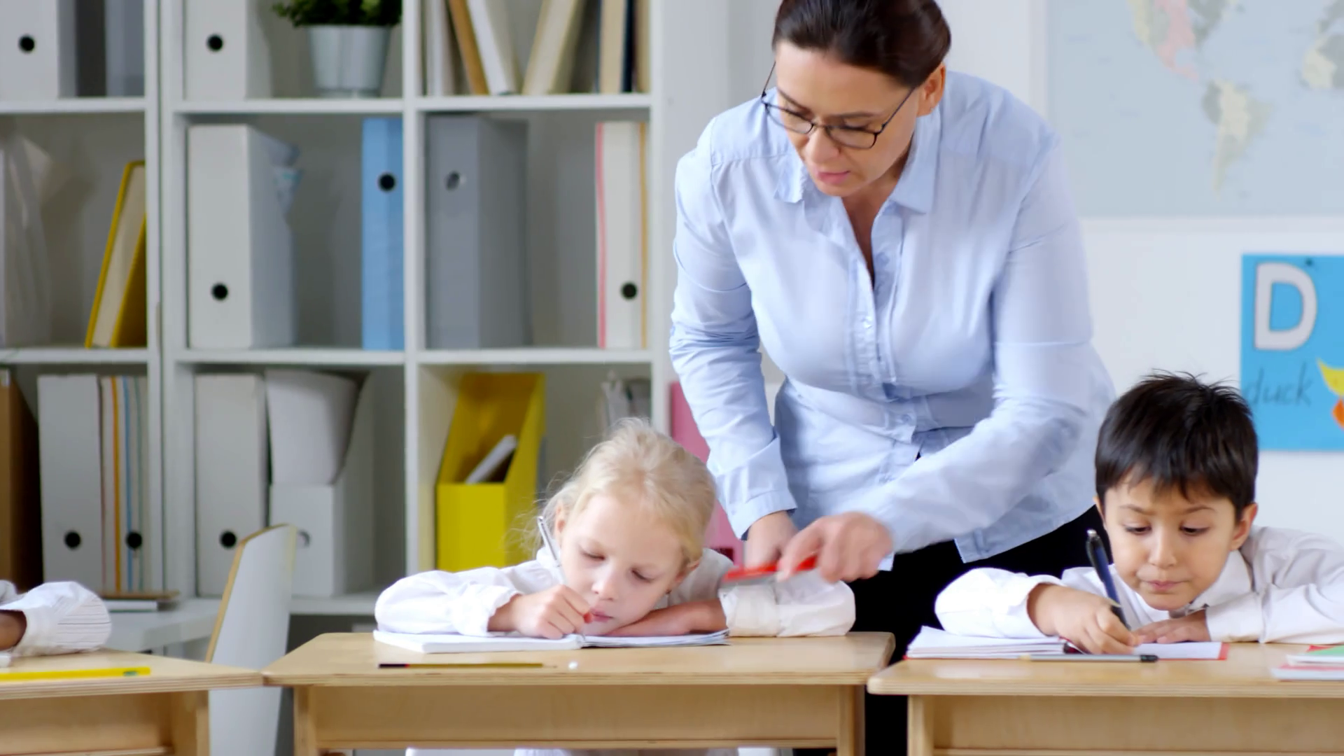 Tracking Shot Of Primary Teacher Assisting Stock Footage SBV-334526319 ...