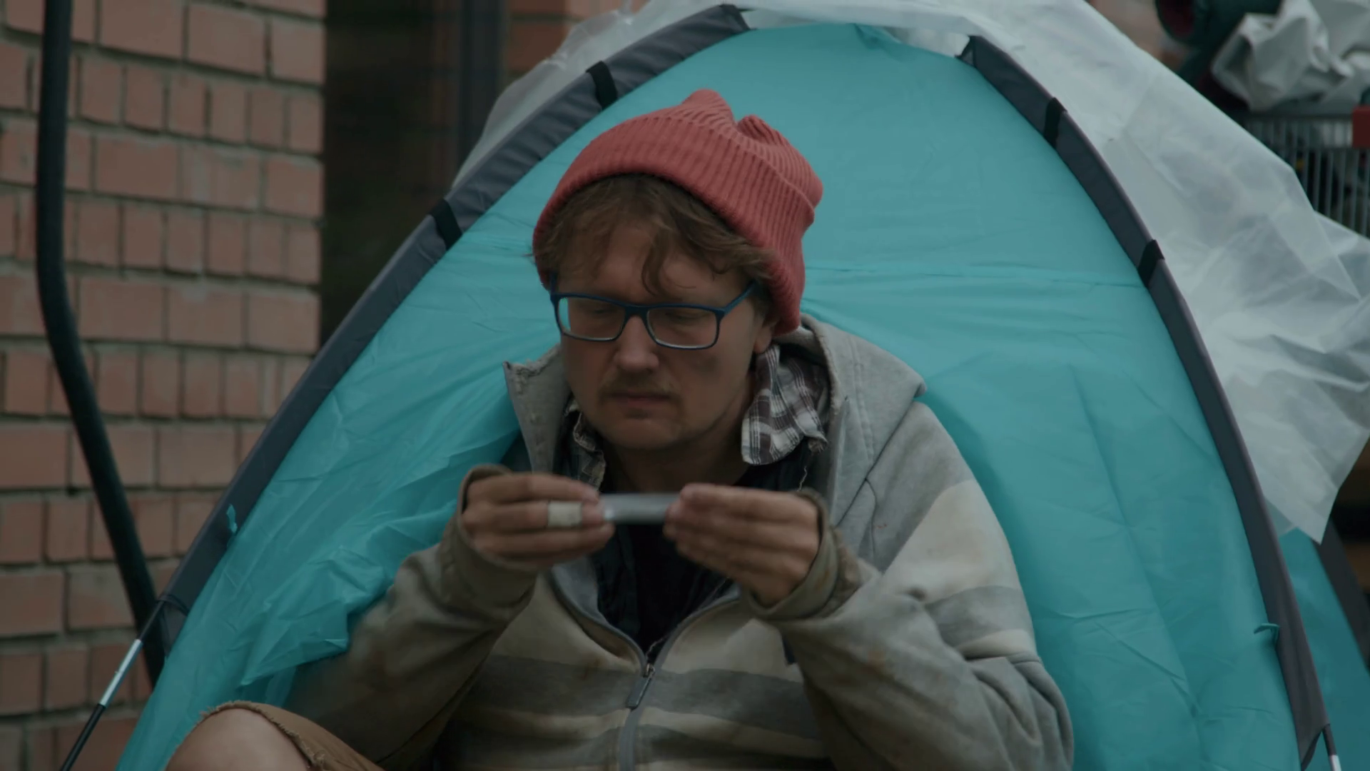 Medium Shot Of Beggar In Rags Making Roll-up Stock Footage SBV ...