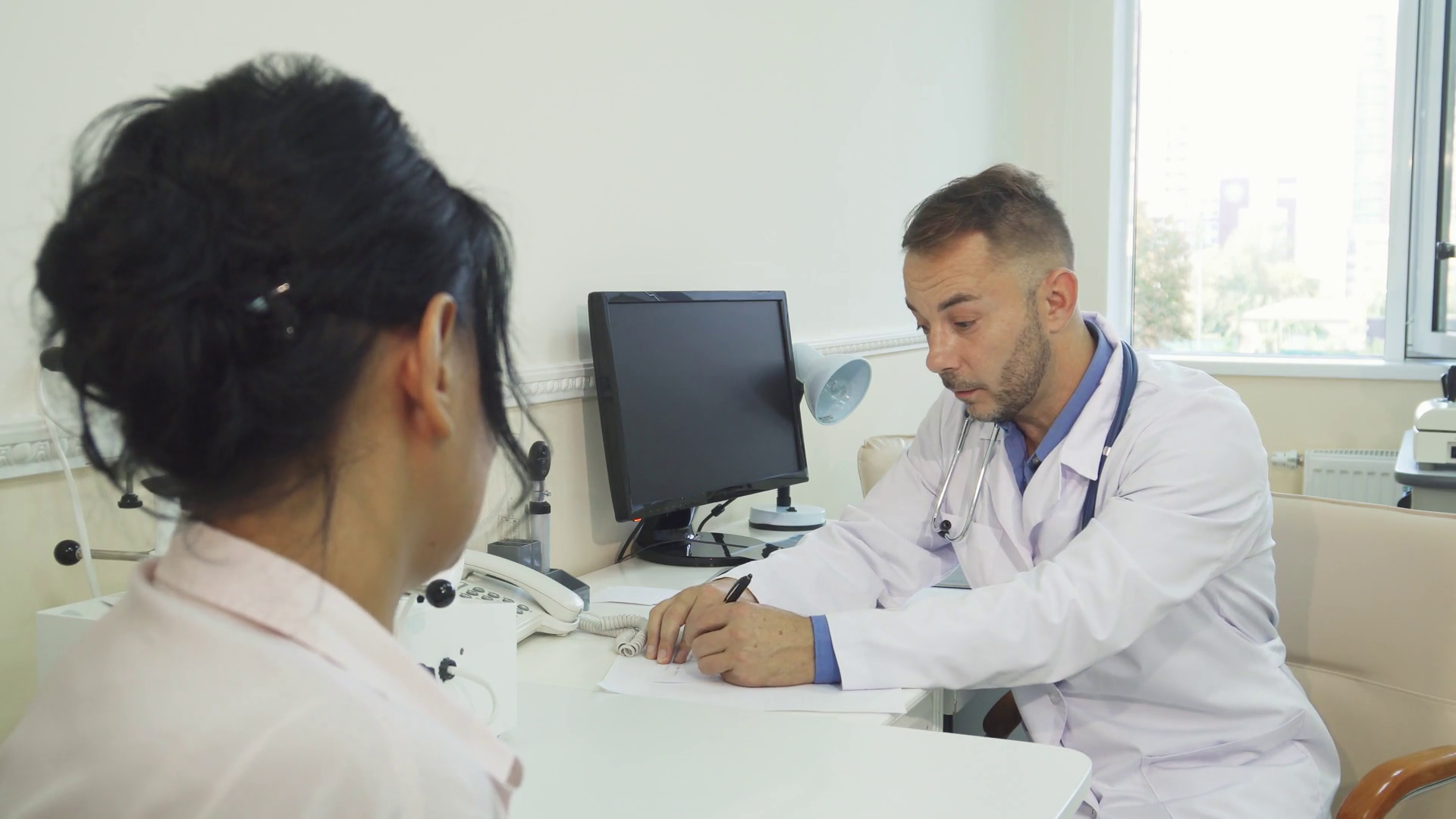 A Calm Doctor Diligently Writes Medical Stock Footage SBV-352170516 ...