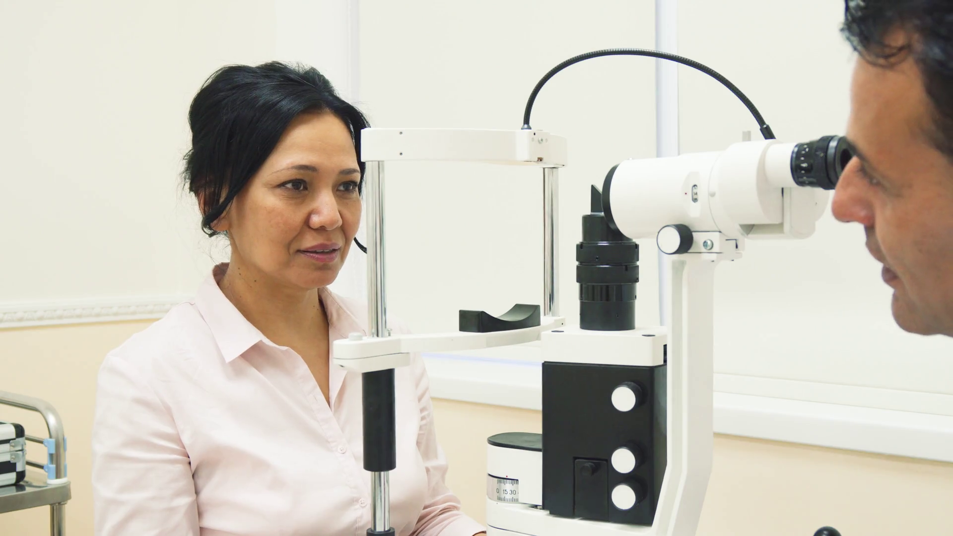 The patient puts his head on a special eye check device Stock Video ...
