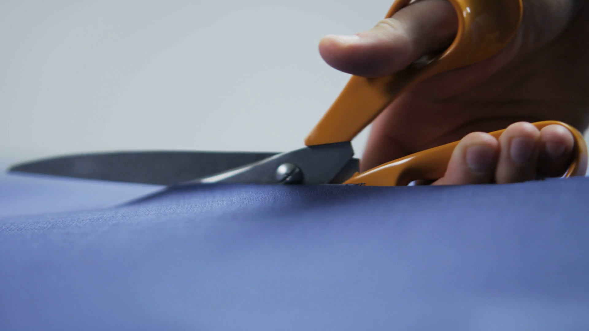 Man Cutting Blue Piece Of Material With Stock Footage SBV-323103561 ...