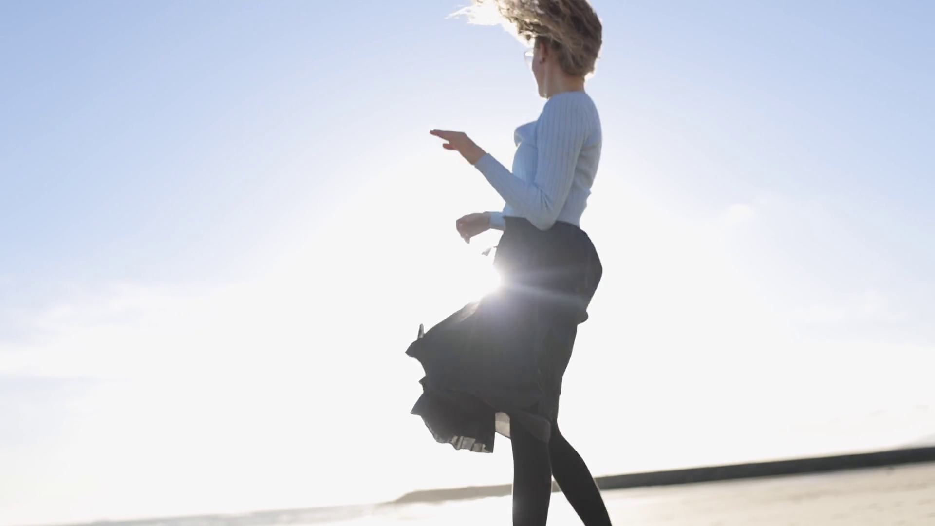 Young Woman Dancing On Beach With Sun Flare Stock Footage SBV-353046299 ...
