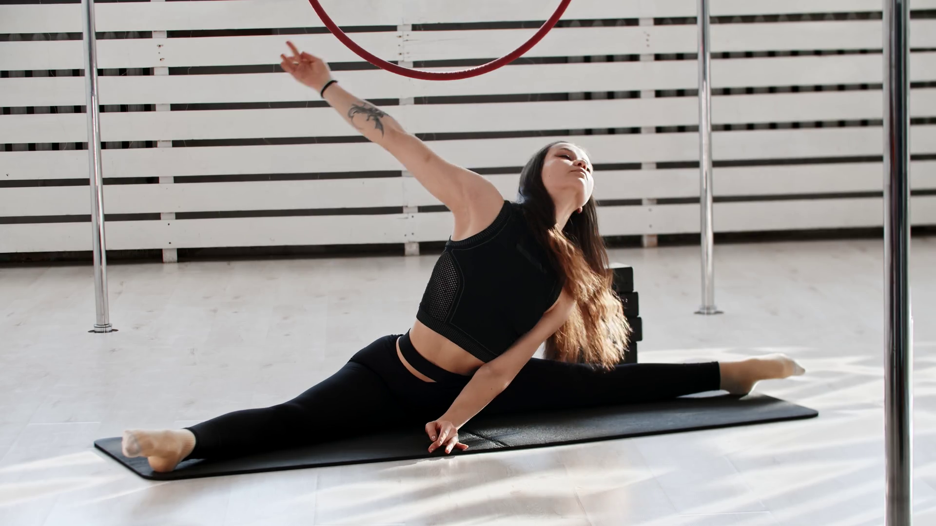 Gymnastic training - young woman sitting in the splits and stretching ...
