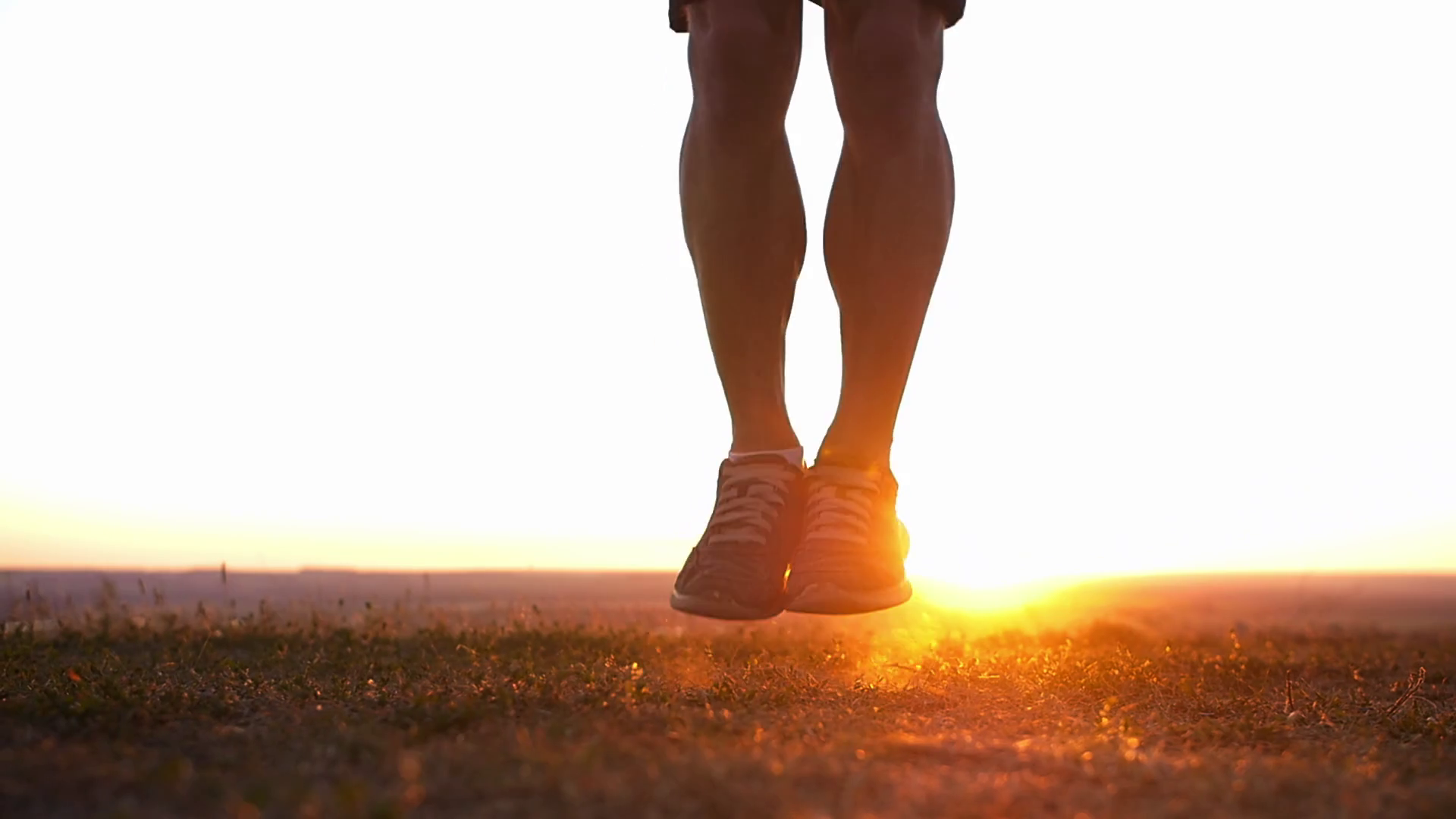 A muscular man jumping over the rope at sunset Stock Video Footage 00: ...