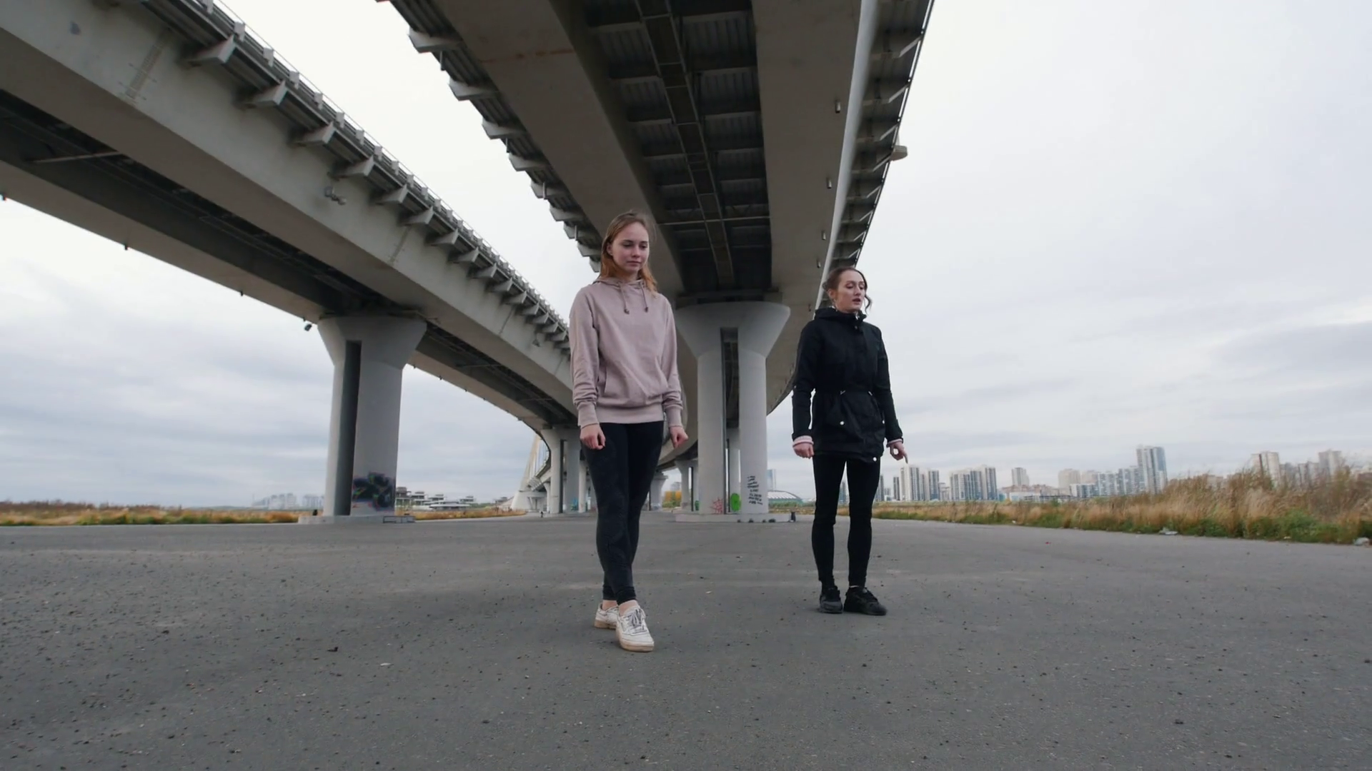 Acrobatic girls jumping in a splits towards the camera on the ...