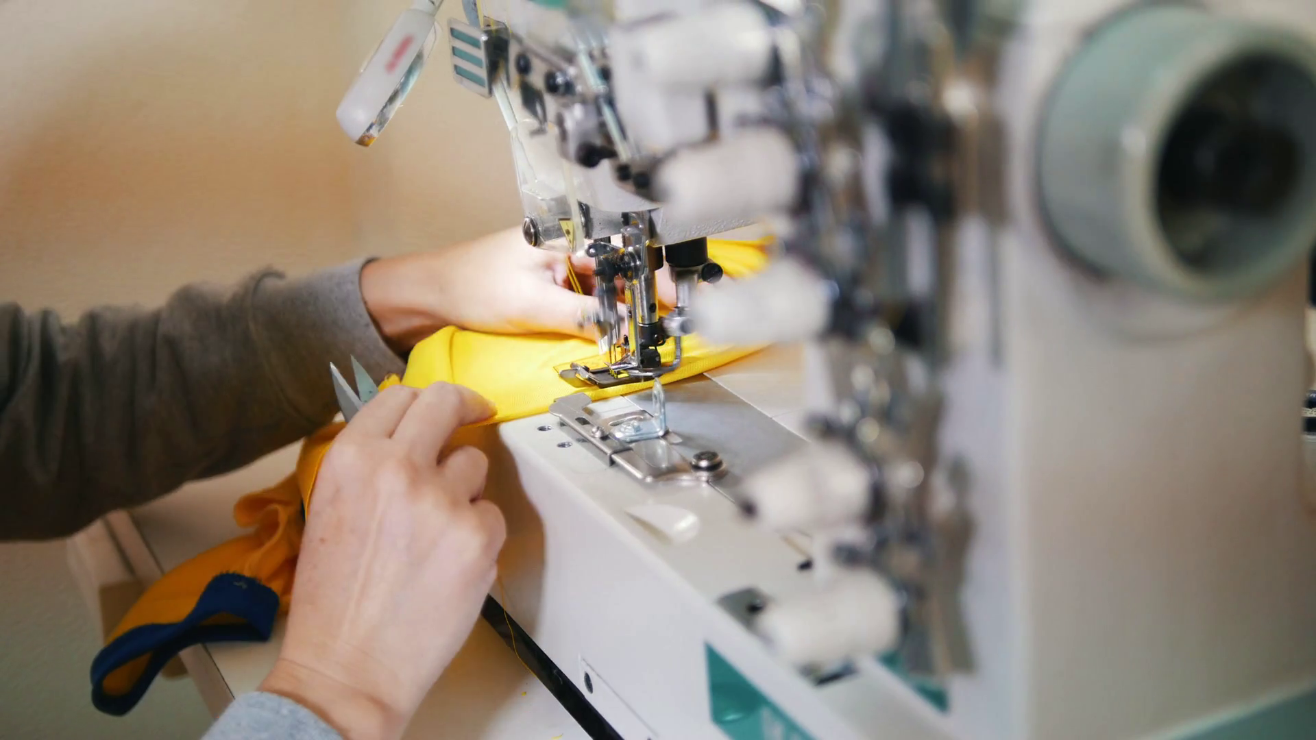 Making Clothes Woman Works On Sewing Machine Focus On Cloth Stock making-clothes-woman-works-on-sewing-machine-focus-on-cloth-stock