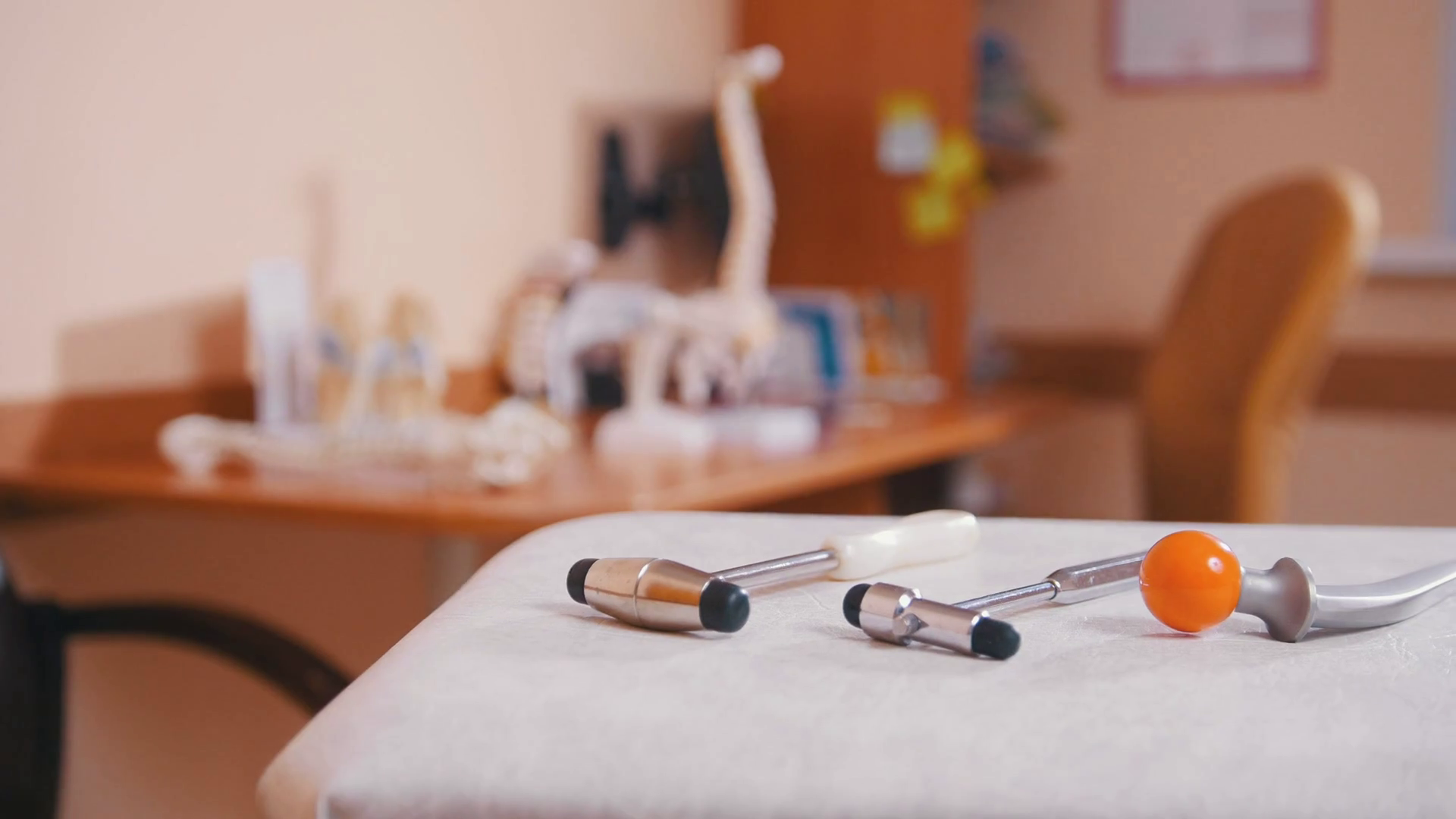 The cabinet of neurologist, medical tools in the foreground, models of ...
