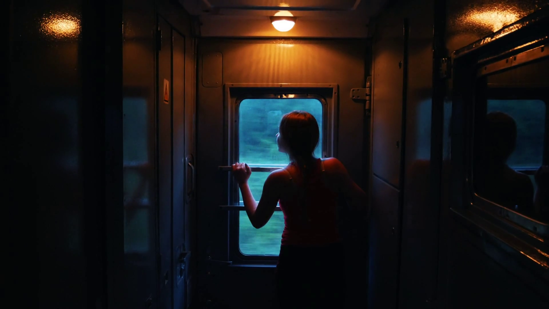 Young girl riding a train, looking out the window, twilight Stock Video ...