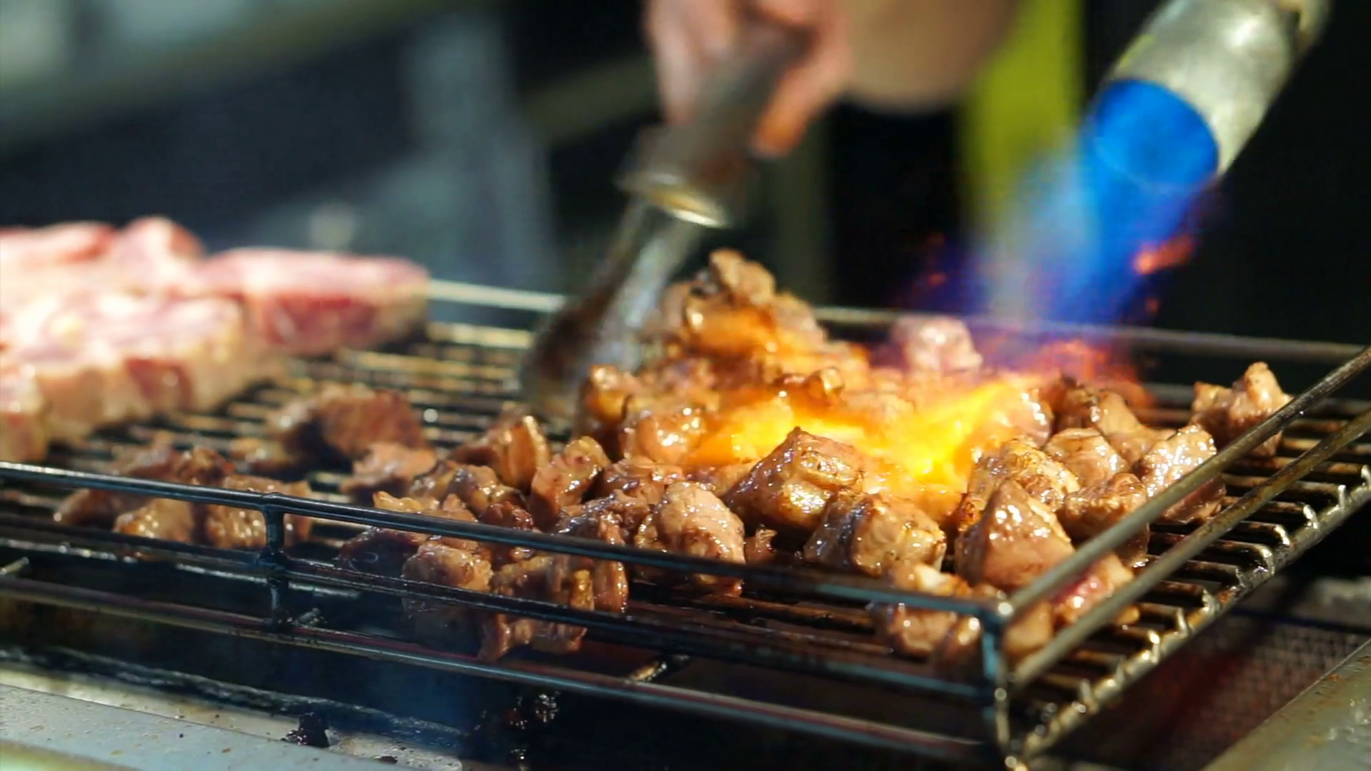 Beef steak dice cooking and flamed on bbq grill oven. Street food ...