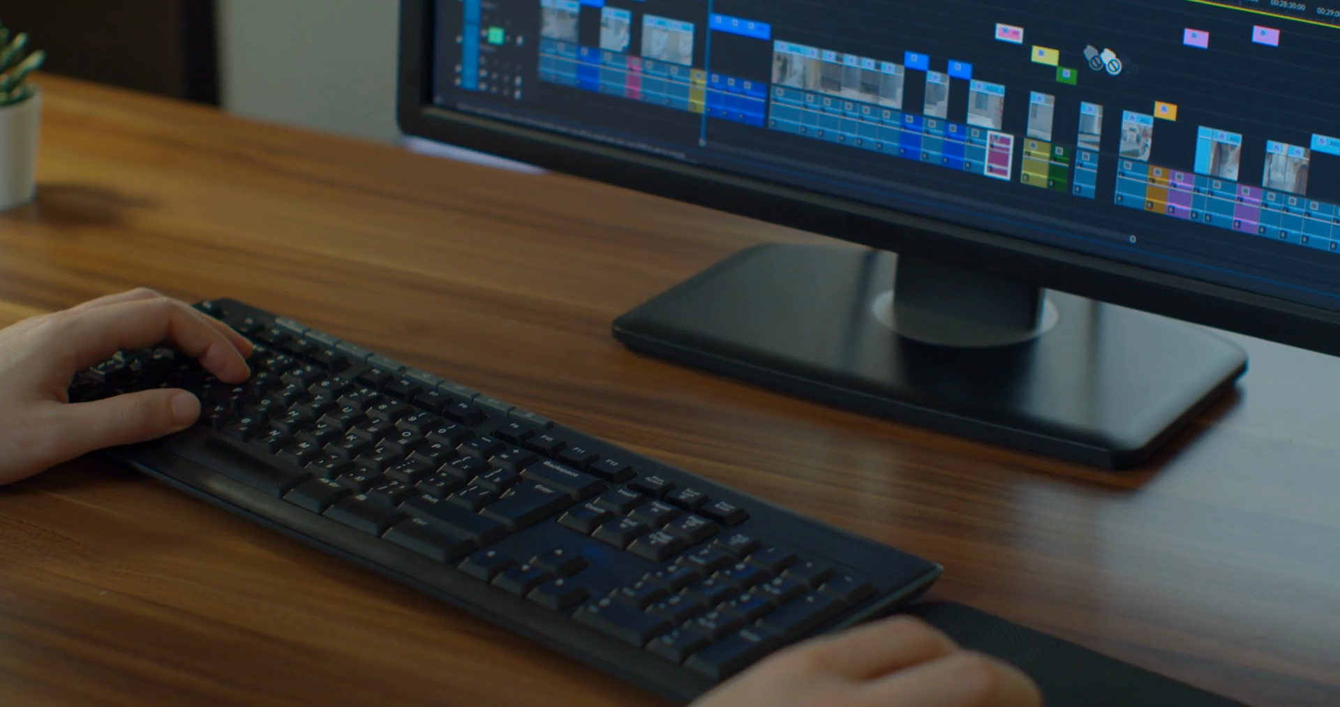 Male Video Editor Works with Footage and Sound on His Personal Computer ...