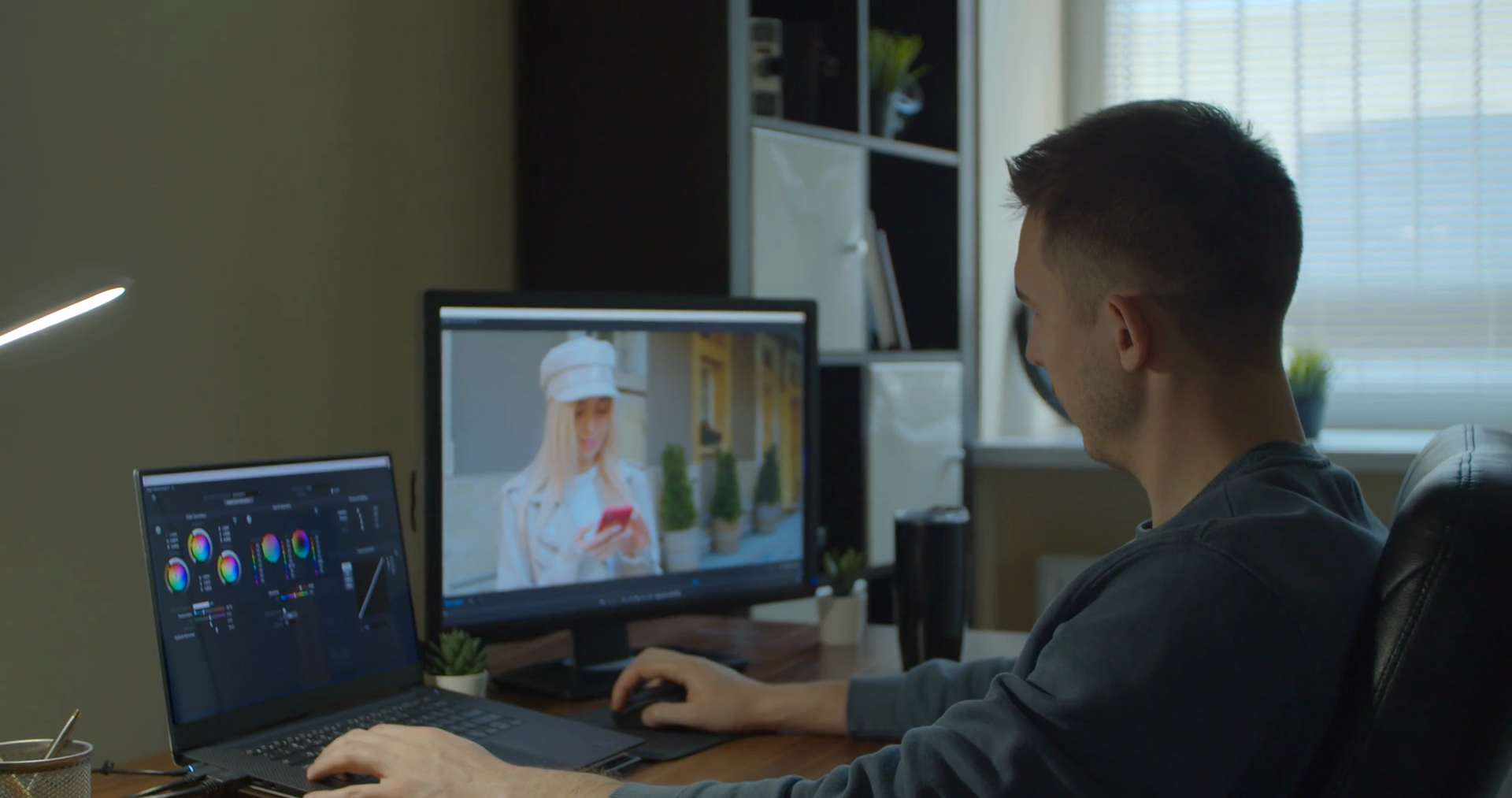 Man working on computer with Two Monitors Color Correction Post ...