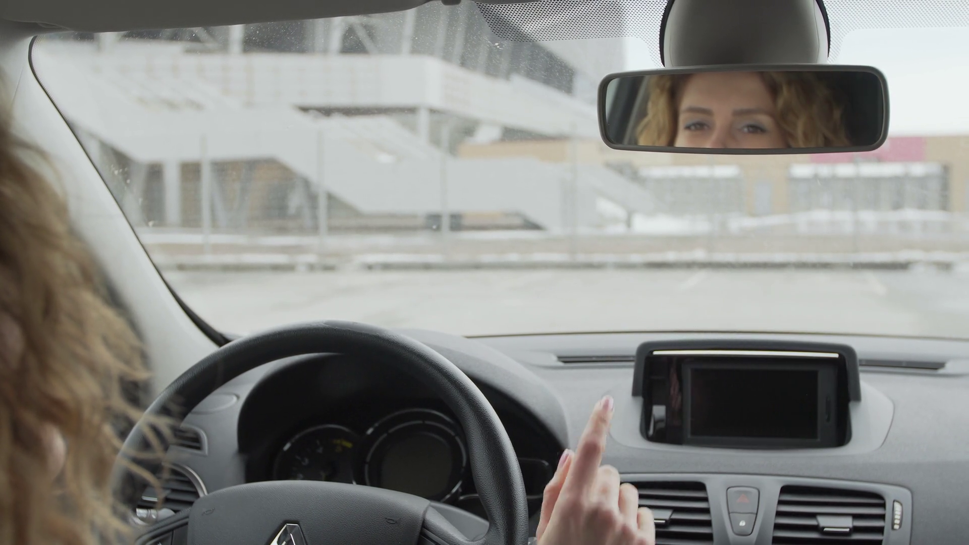 Woman looking at camera through rear view mirror, woman driving car ...