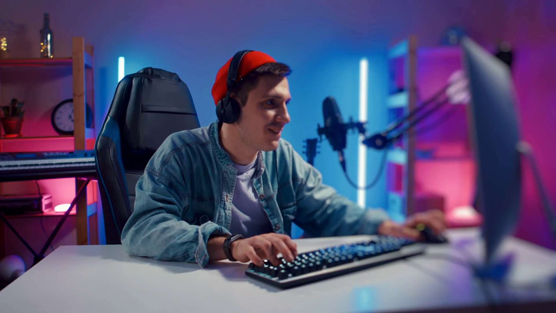 Young hipster man playing online computer video game, colorful lighting ...