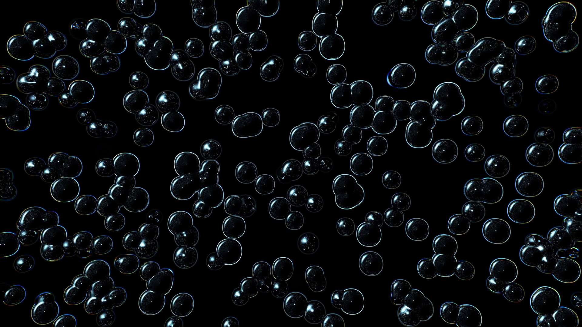 Bubbles multiplying and bursting against a black background. Motion ...