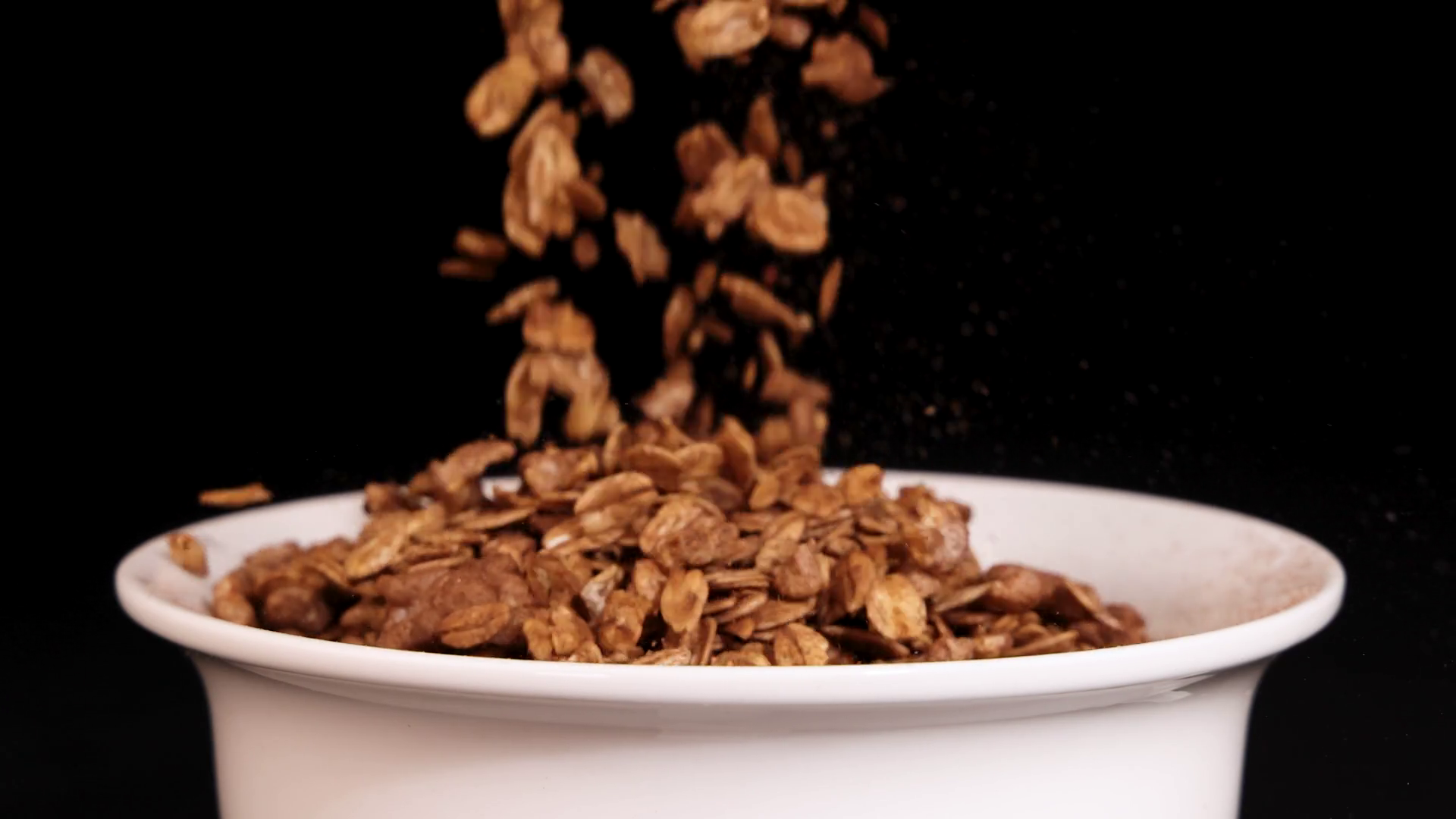 Granola Falling Into Bowl Against Black Stock Footage SBV-352535301 ...