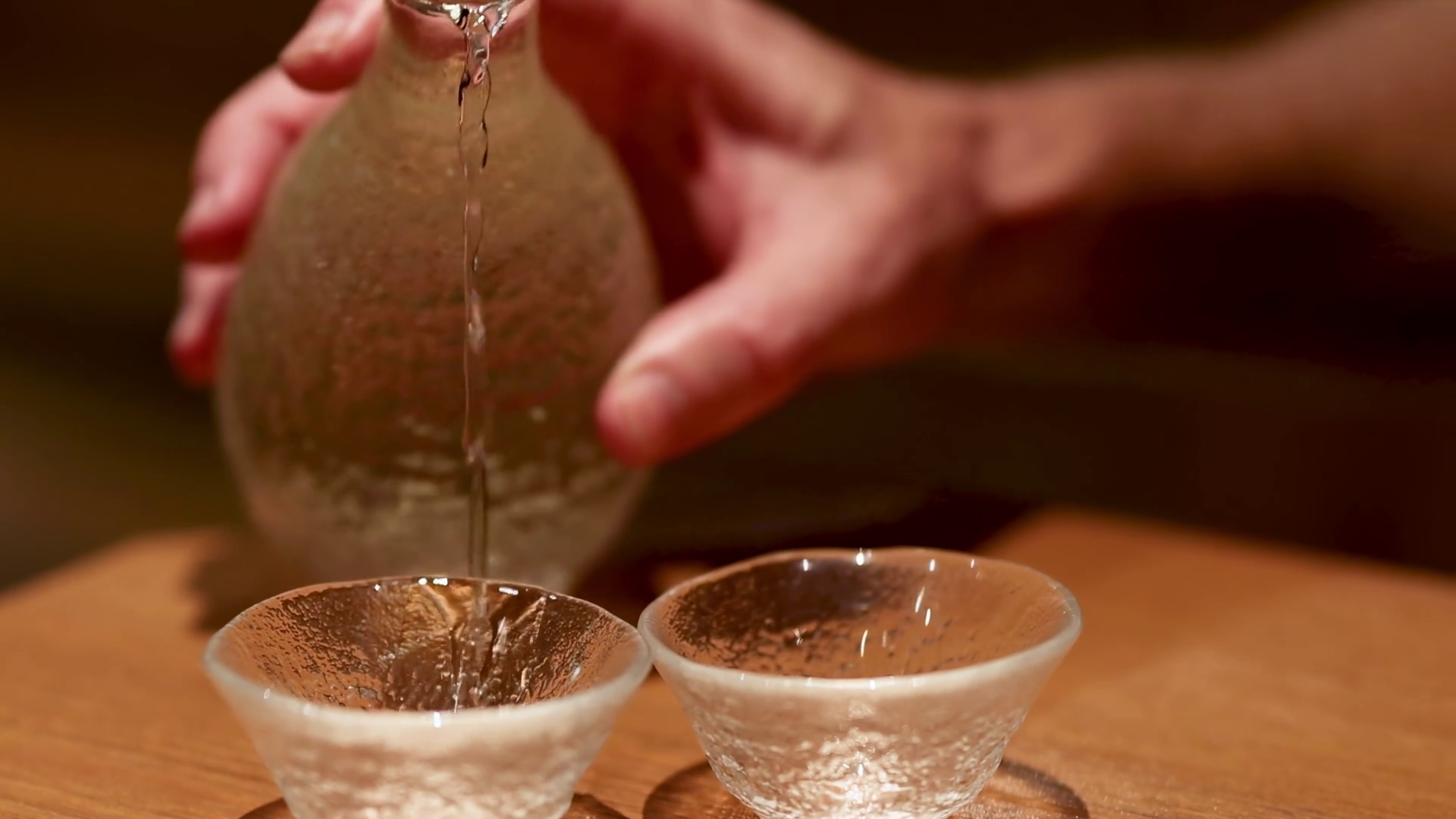 Hand Pouring Clear Liquid Into Glass Cups Stock Footage SBV-353330593 ...