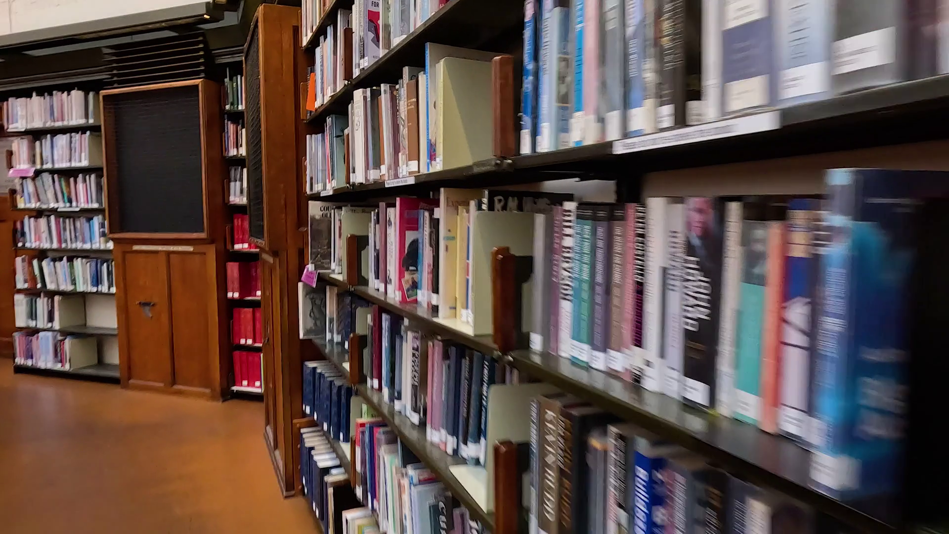 Walking Past Bookshelf In Library Stock Footage SBV-352774717 - Storyblocks