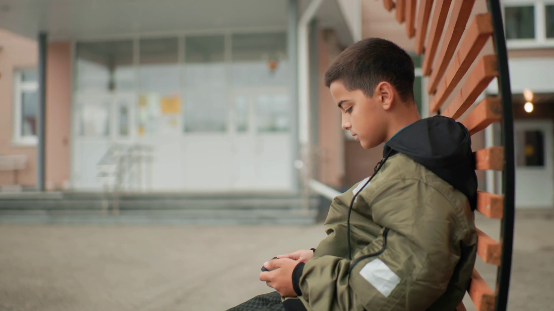 Side View Of Boy Sitting On Bench Wearing Stock Footage SBV-352713483 ...