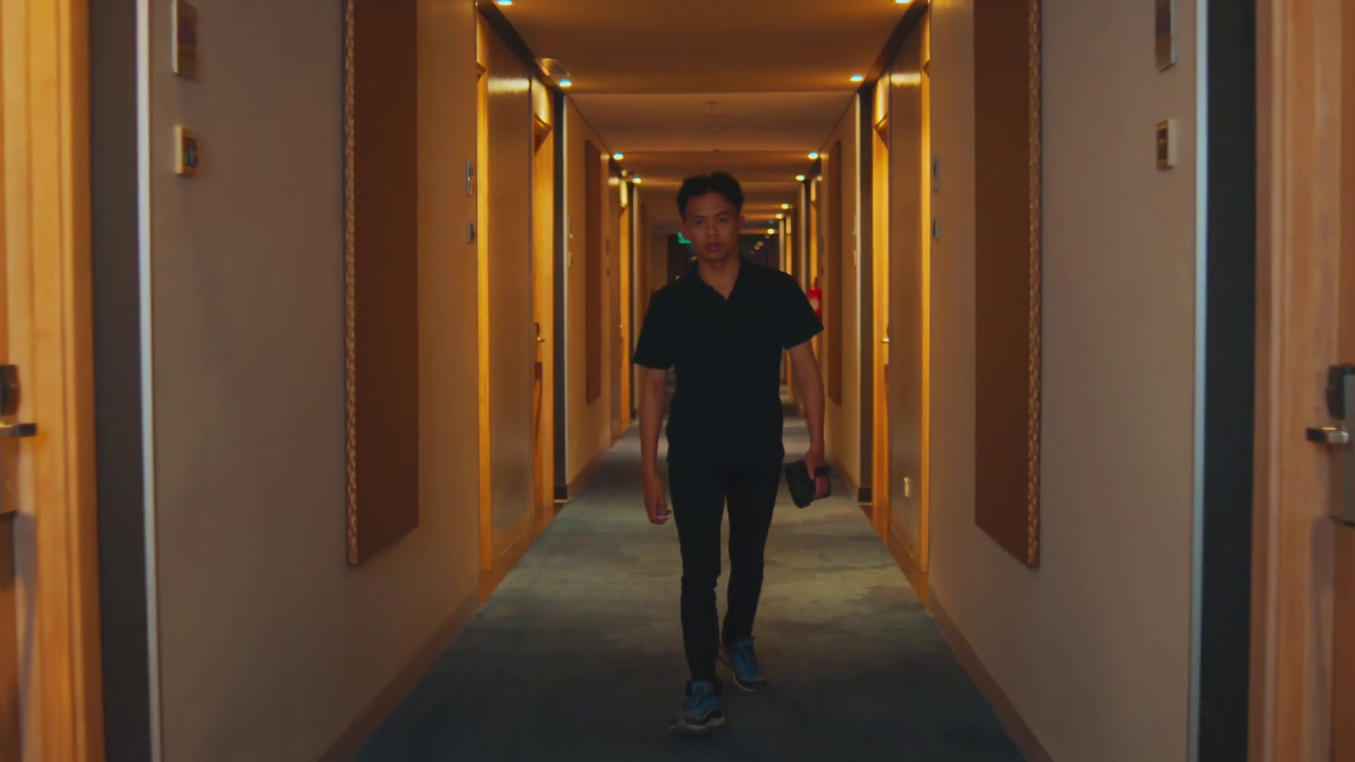 A Hotel Visitor Walks Down Hallway Full Of Stock Footage SBV-348410281 ...