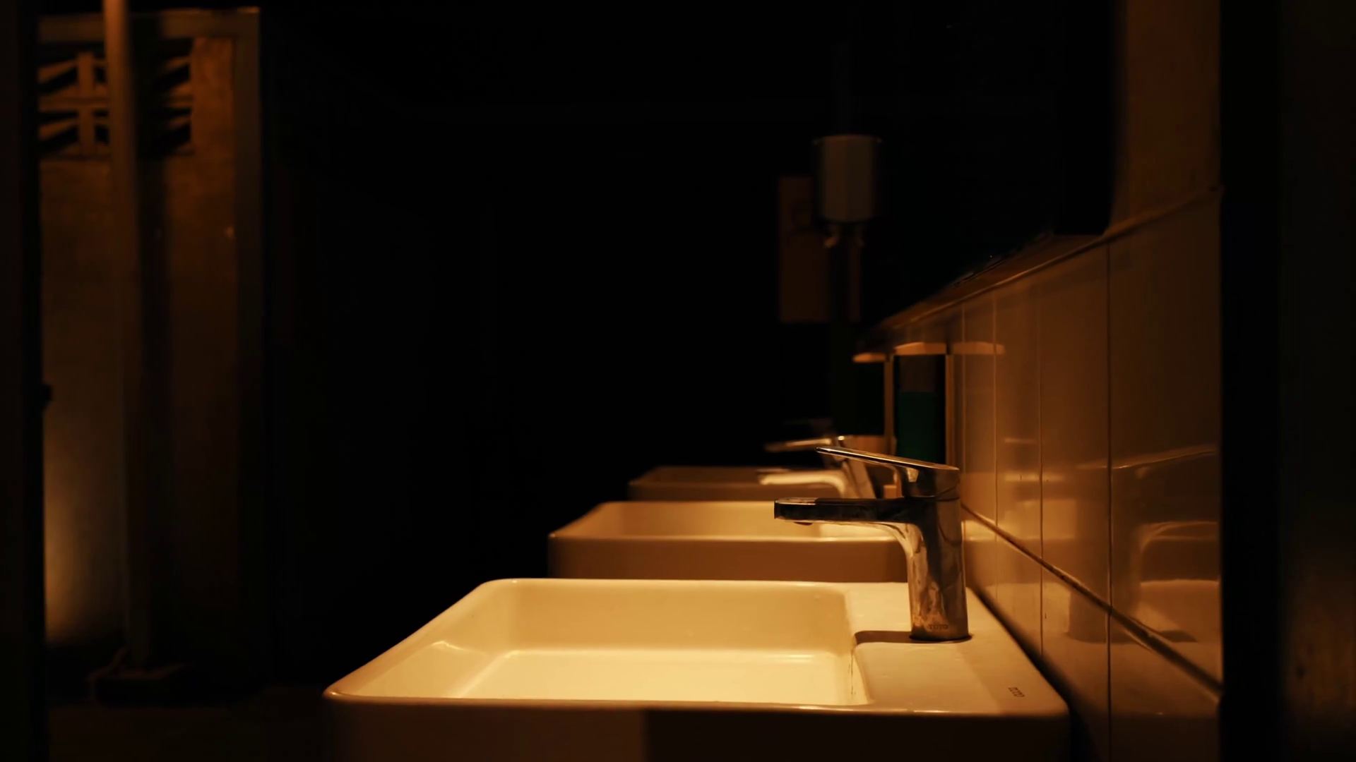 Dimly Lit Public Bathroom With Row Of White Stock Footage SBV-348808576 - Storyblocks