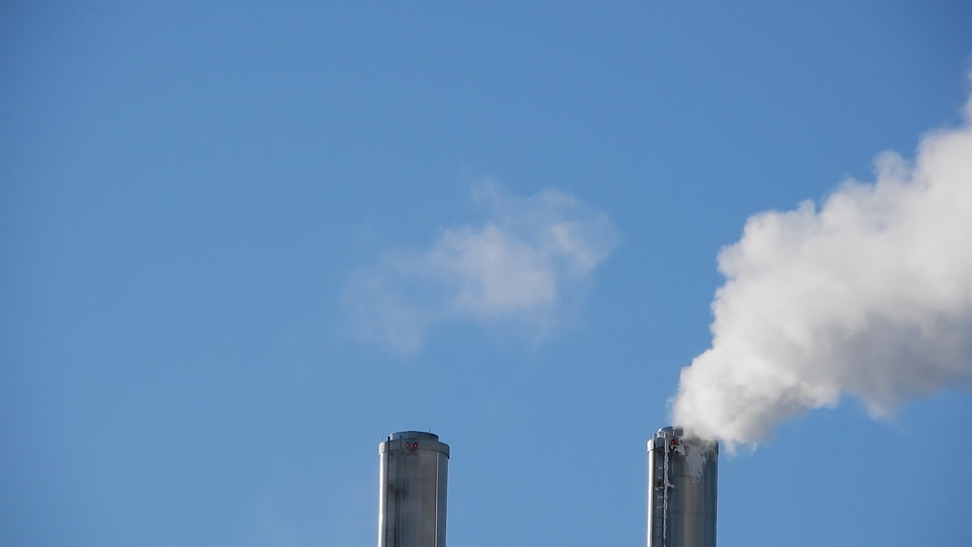 A Close-up Shot Captures Two Smokestacks Stock Footage SBV-347787981 ...