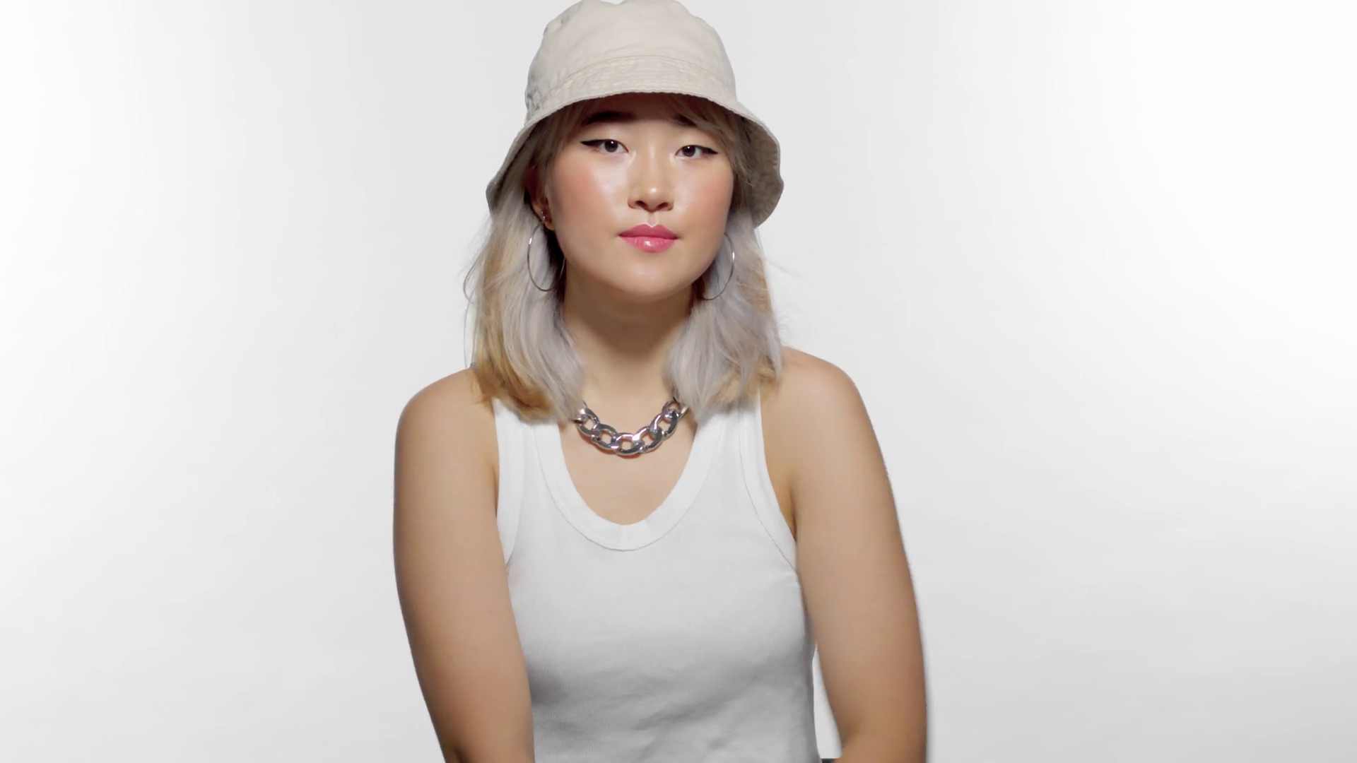 zoom in dolly blonde korean model with thongue out and v-sign hand ...