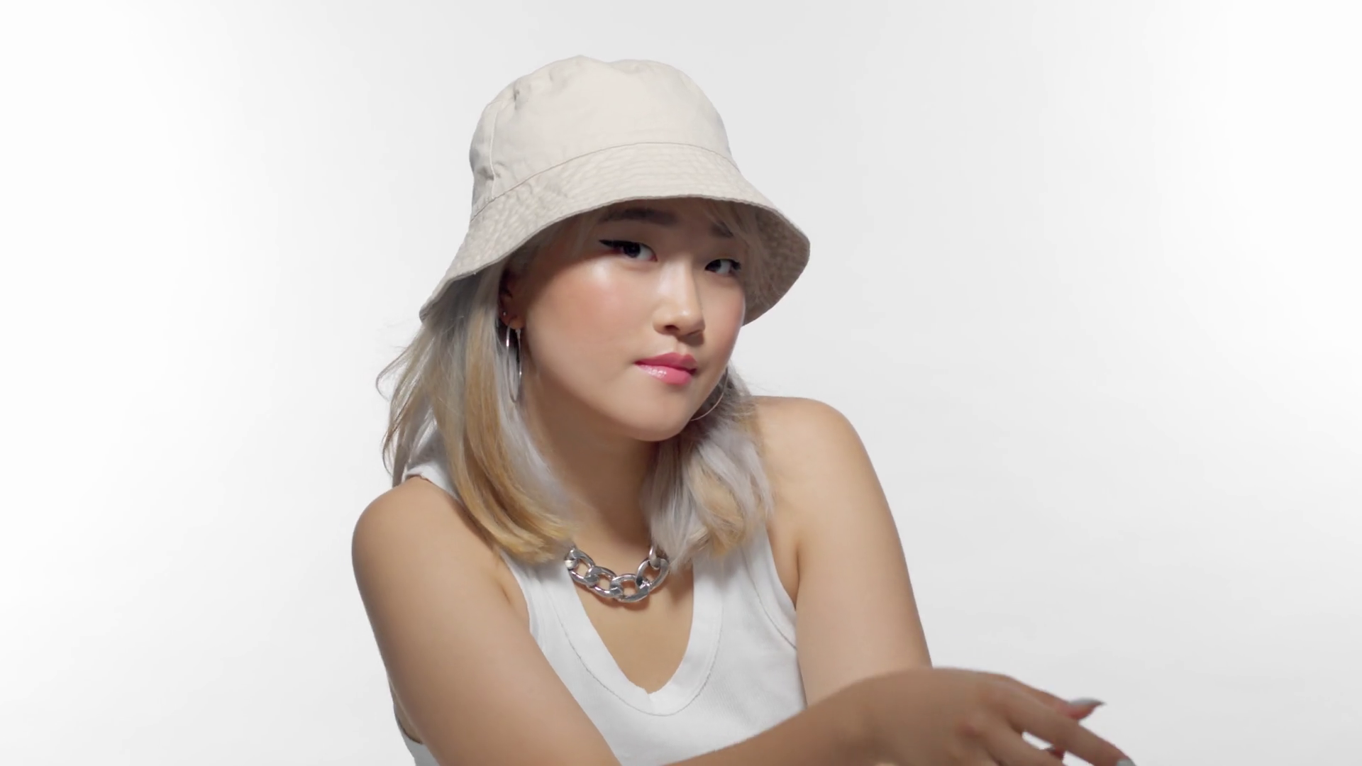 zoom in dolly blonde korean model with thongue out and v-sign hand ...