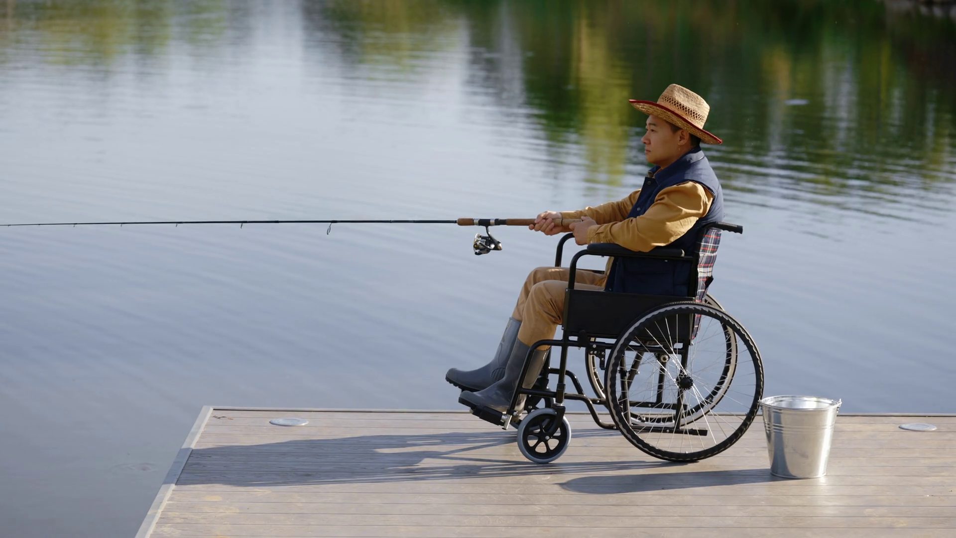 Disabled fisherman on the wheelchair fishing on the local lake on the ...