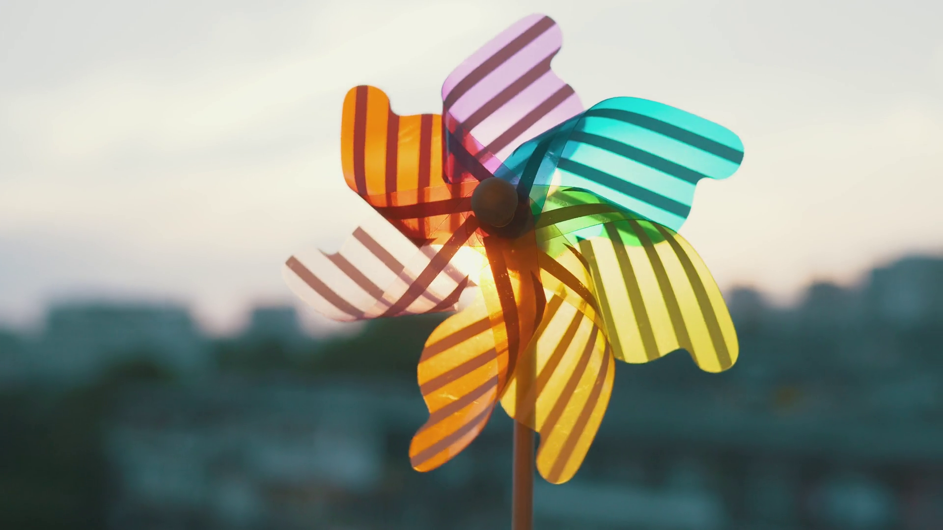 Pinwheel rotating colored plastic with blowing wind against a blue sky ...