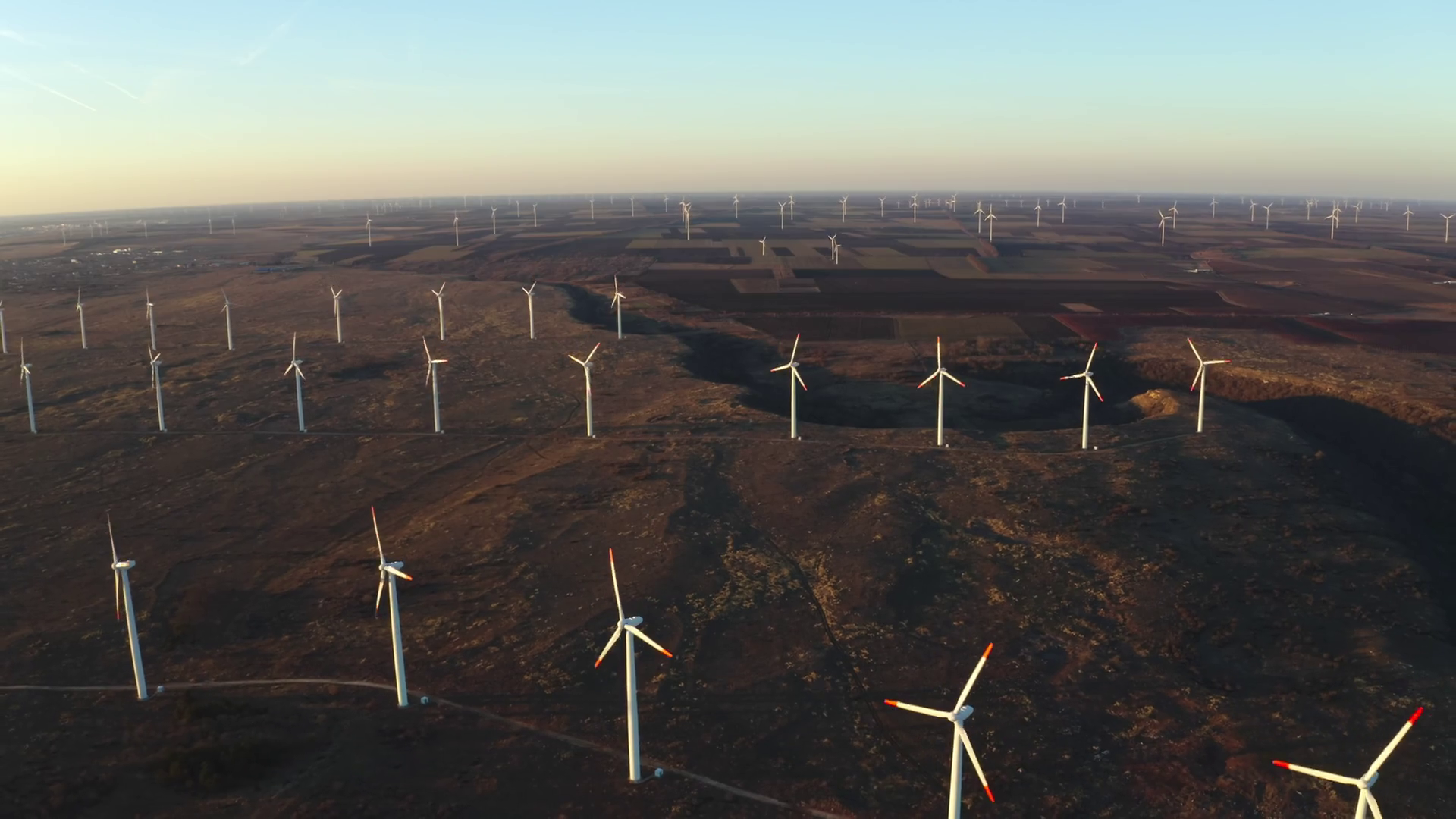 Wind turbines blades in field Aerial view against backdrop of bright ...