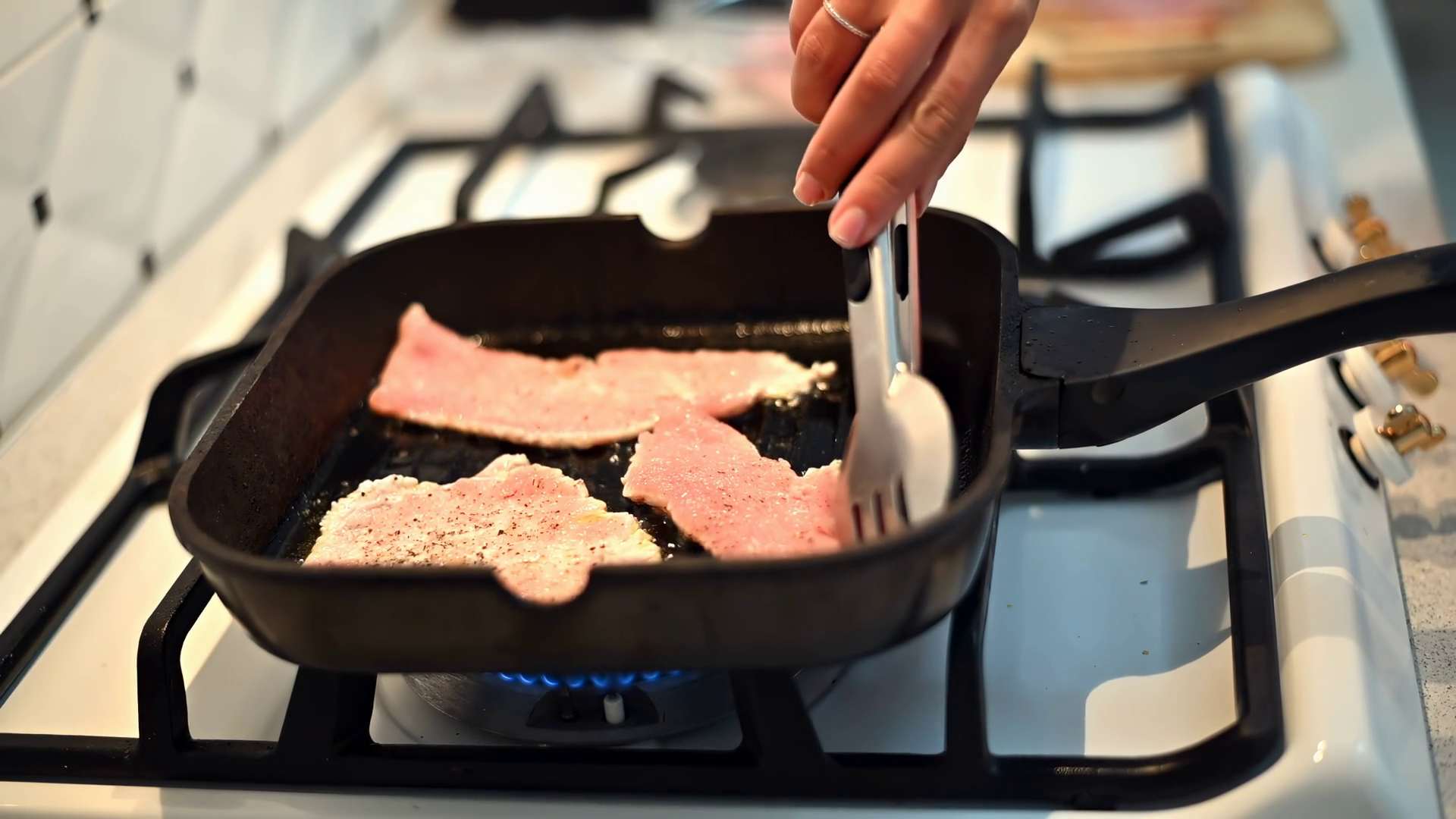 Sizzling Bacon Cooks In Skillet On Gas Stove Stock Footage SBV ...