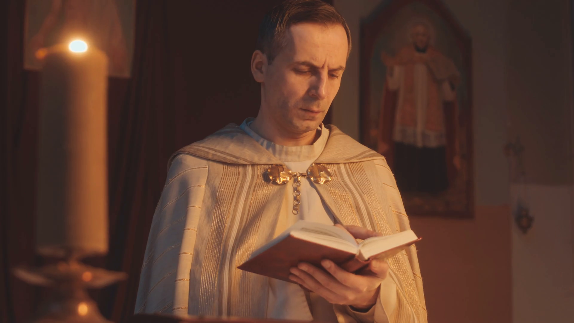 Medium slowmo of Caucasian priest in white vestment reading Holy Bible ...