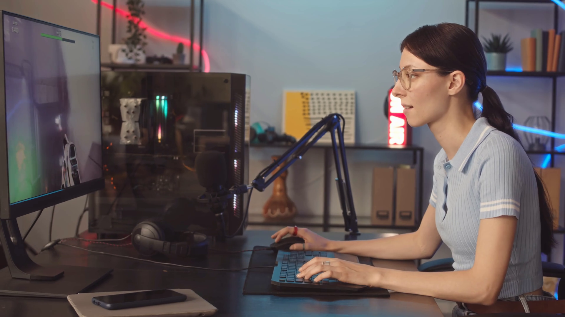 Medium shot of concentrated Caucasian girl in her early 20s playing fps ...