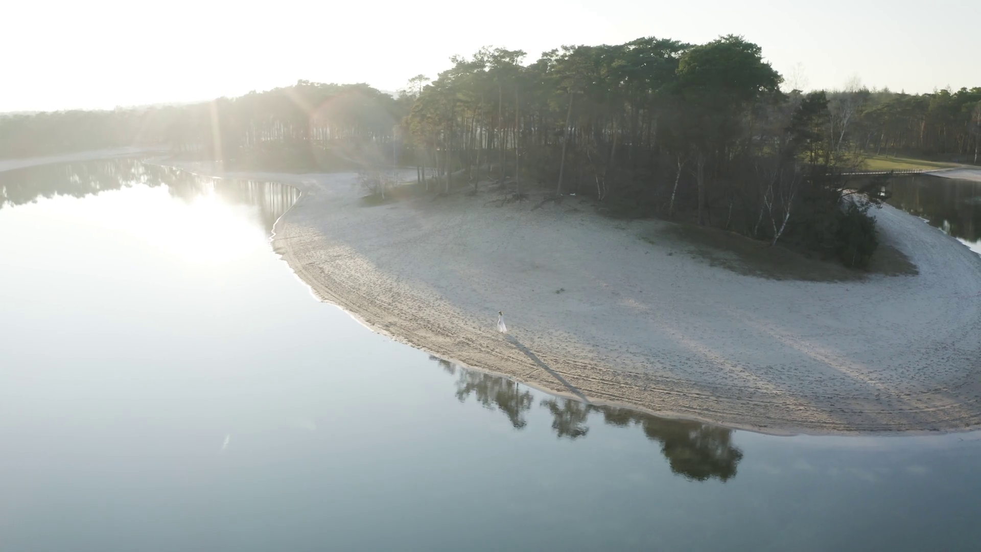Aerial view of a woman walking along th shoreline at Recreatiegebied ...