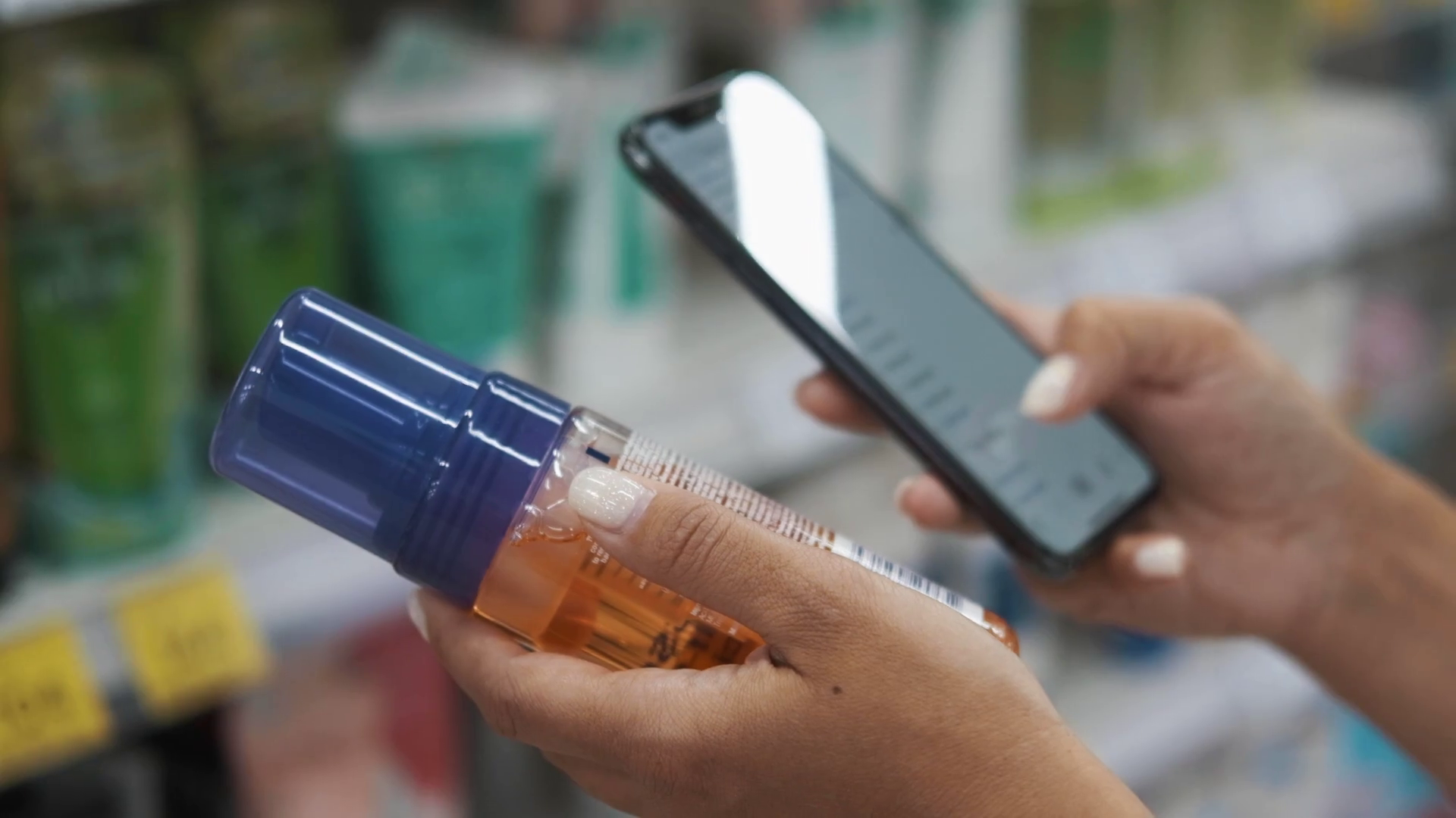 Female hands closeup customer reading label on cosmetic bottle in store ...