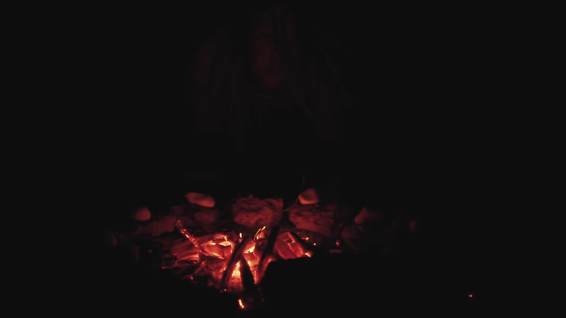 Scary witch does voodoo black magic ritual near the fire at night ...