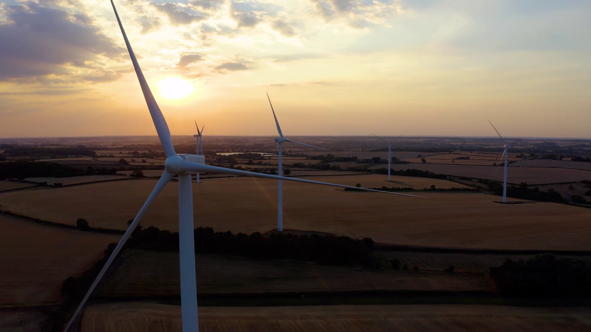 Wind Turbines Turning At Sunset Over Rolling Stock Footage SBV ...